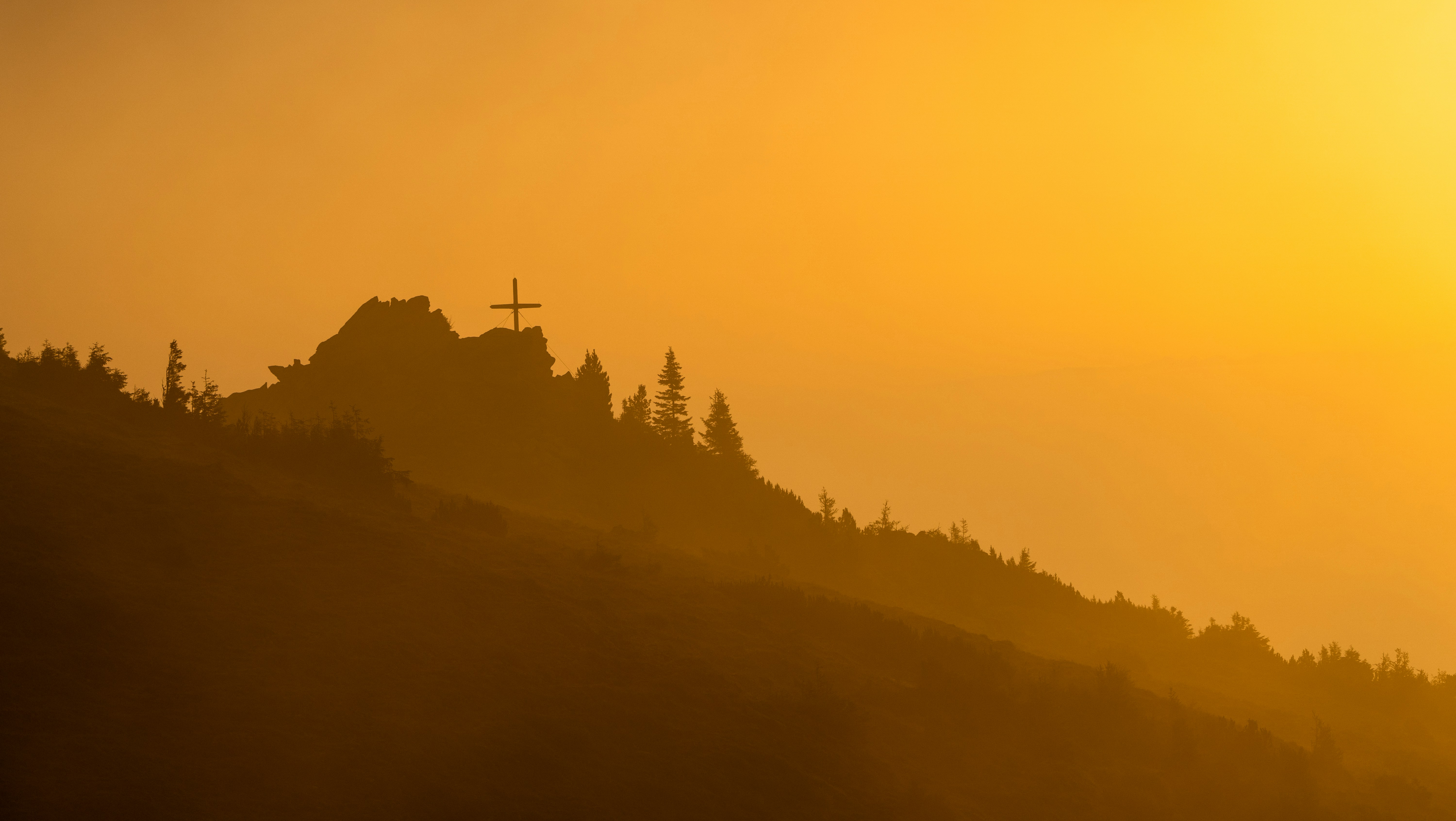 The sun is setting over a hill with a church on it photo – Free Hochalm ...