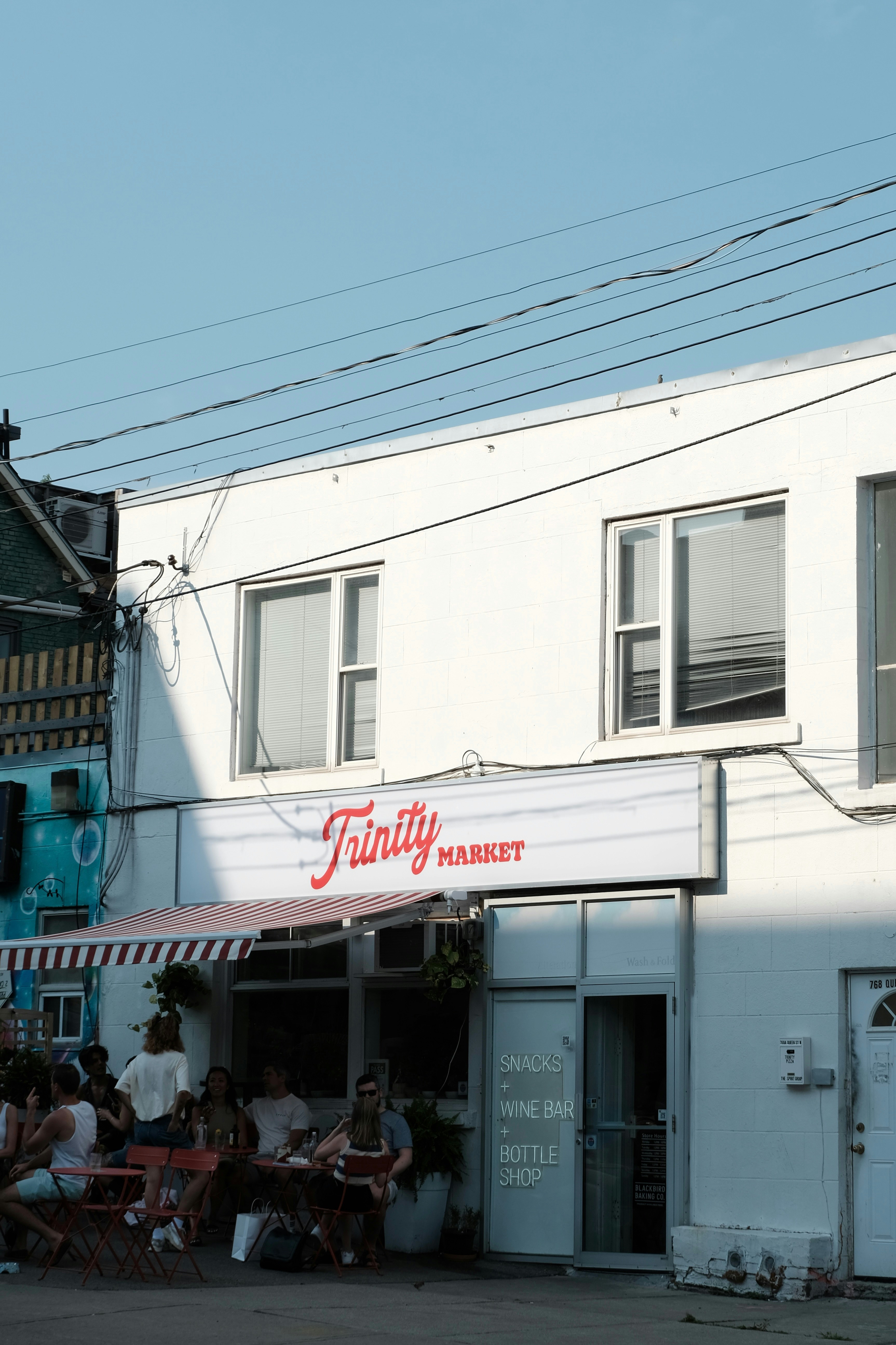 Trinity Market Signage Over a Sunlit Street Café