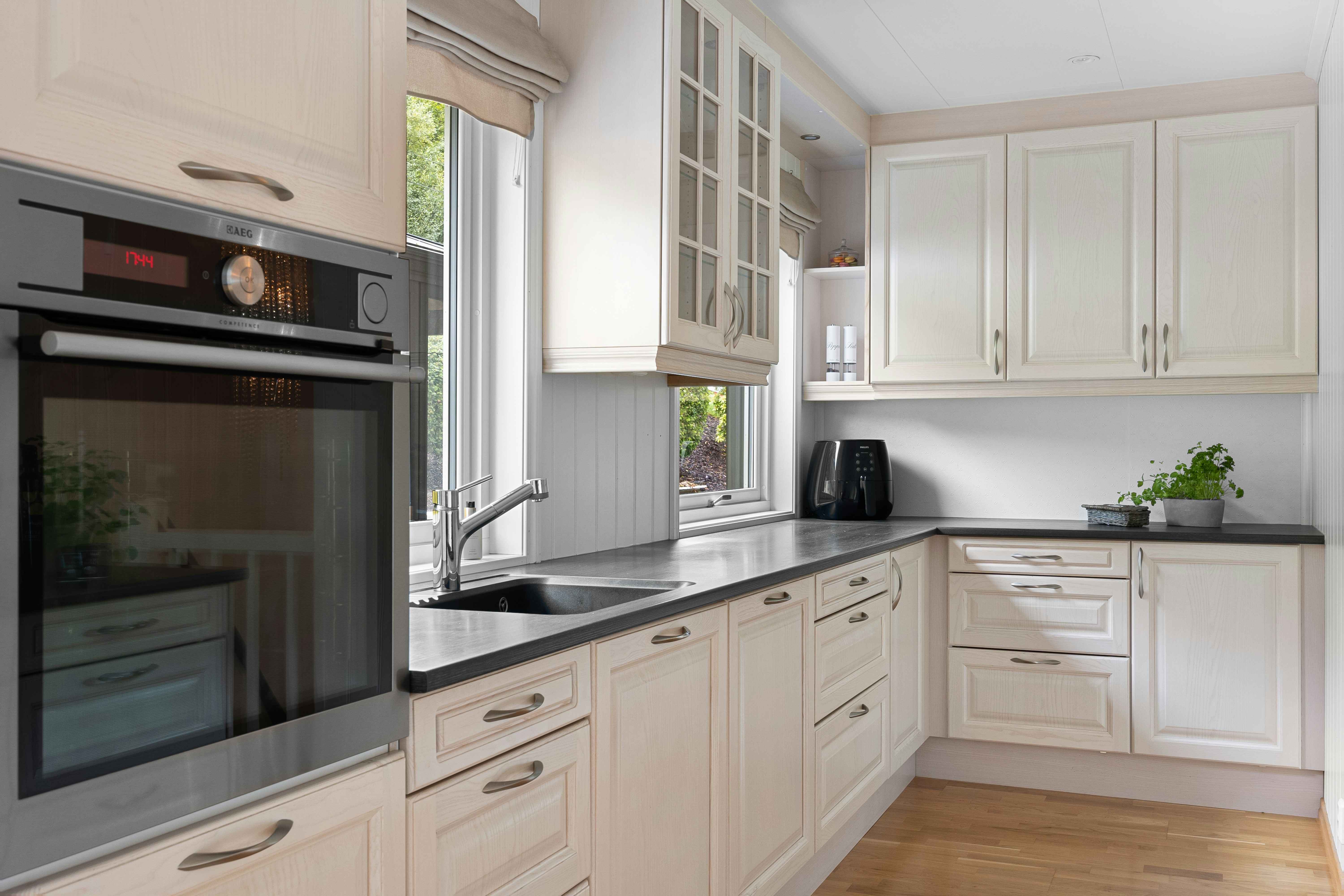 A kitchen with white cabinets and a silver oven photo – Free Indoors ...