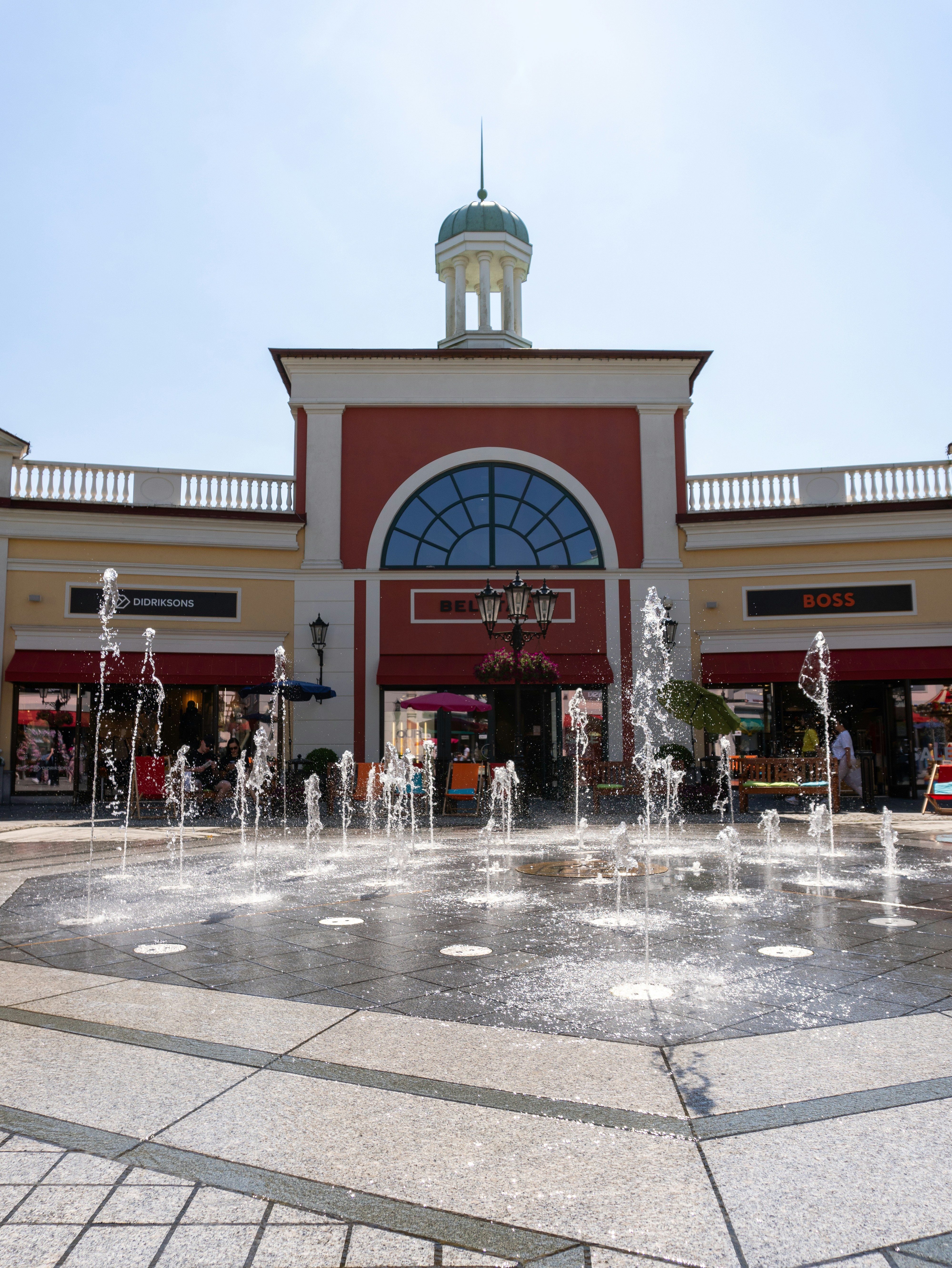 Central Archway Fountain: Sunlit Arcade in a Symmetrical Plaza