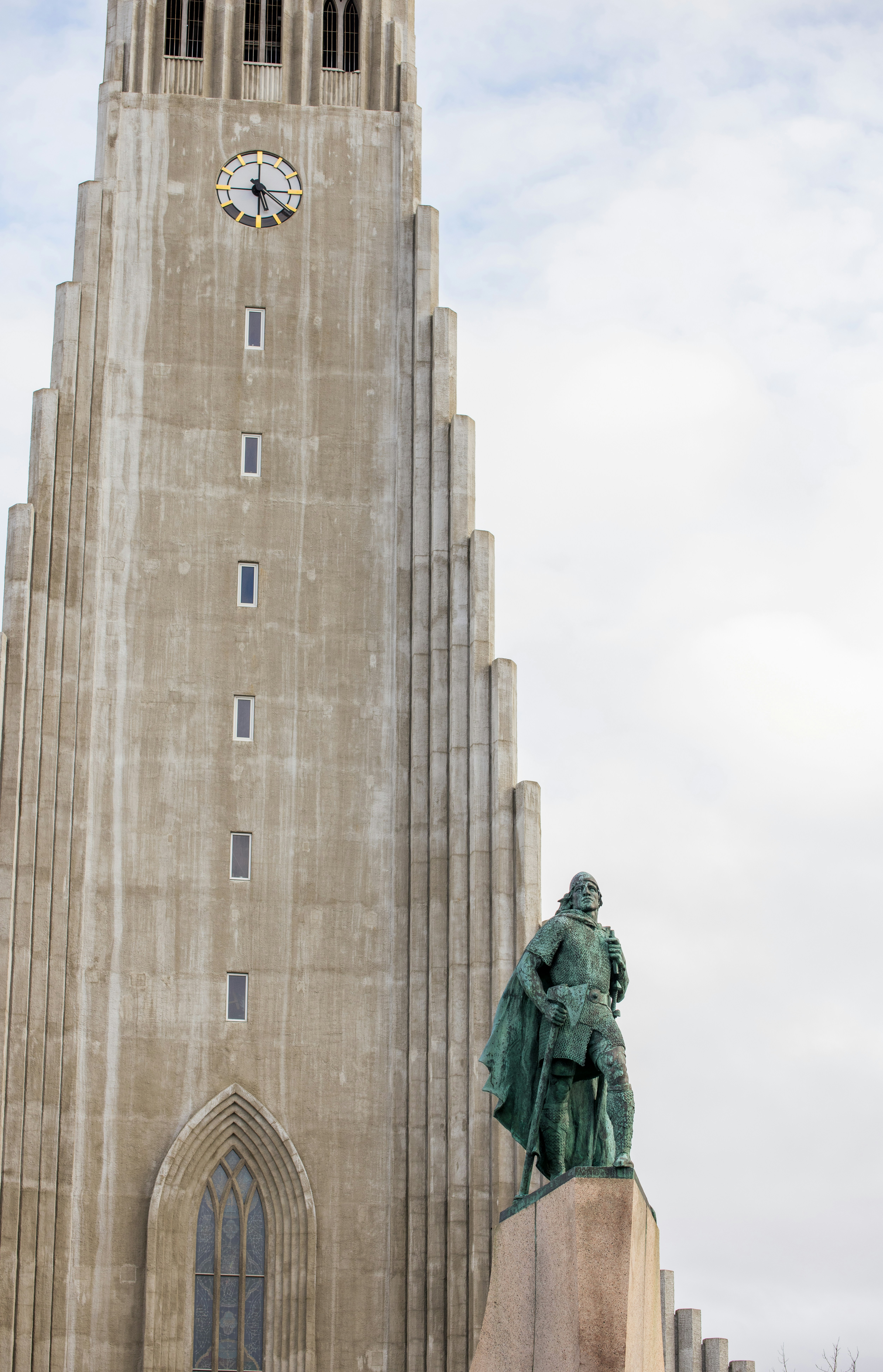 Clock Tower silhouette: a heroic statue beside the towering spire