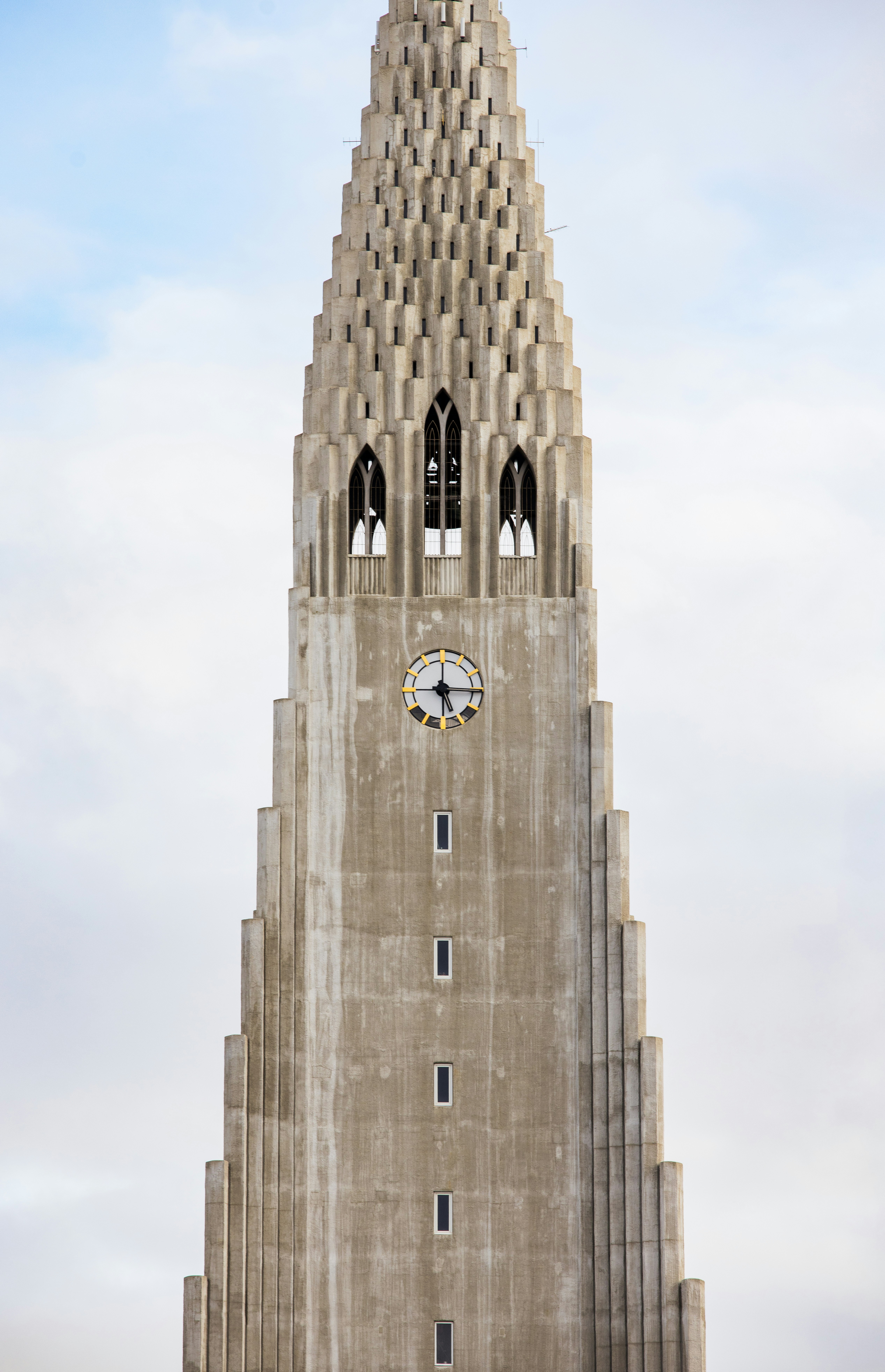 A very tall building with a clock on it's side photo – Free Iceland ...