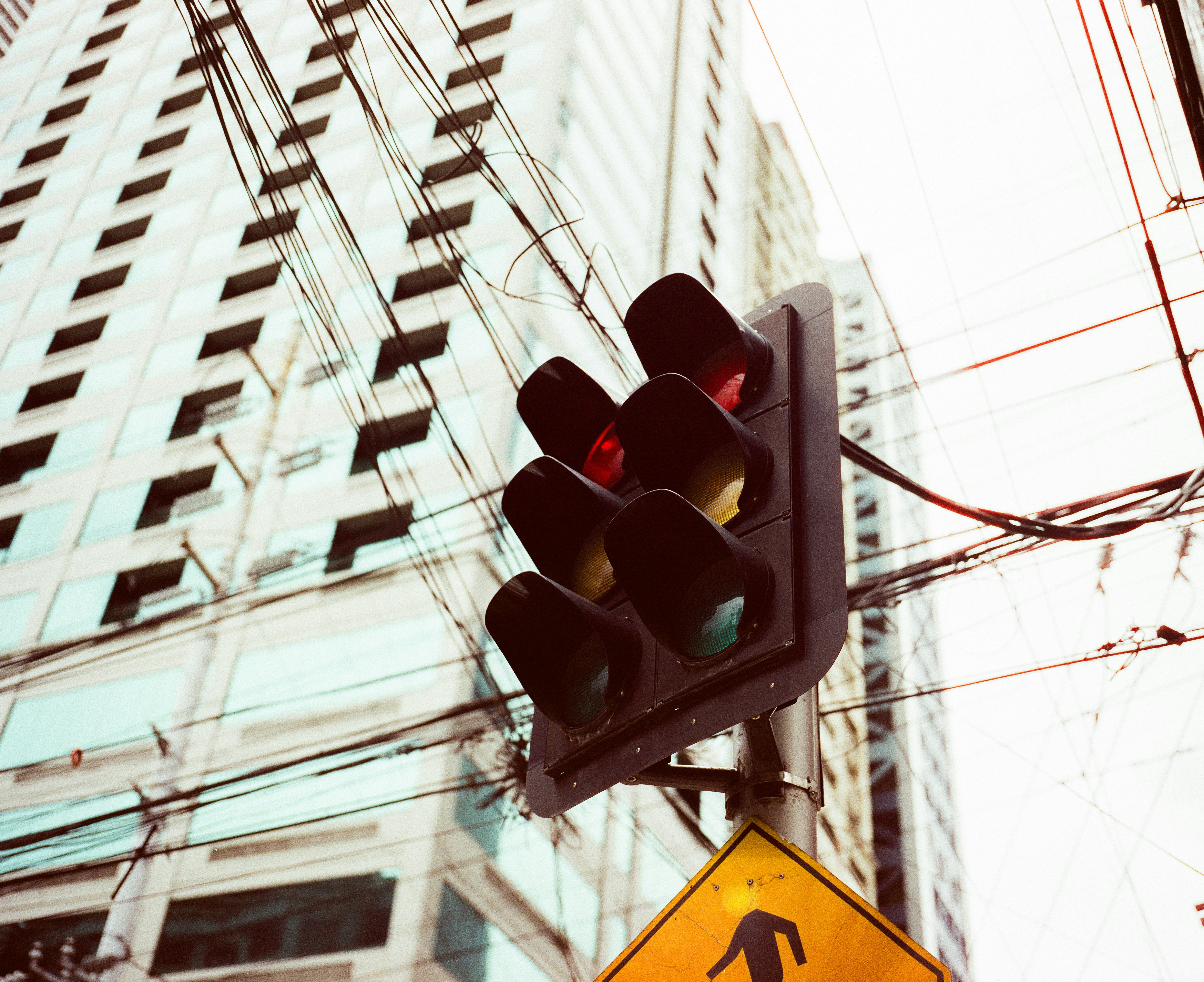 A traffic light hanging from the side of a pole photo – Free Analog ...