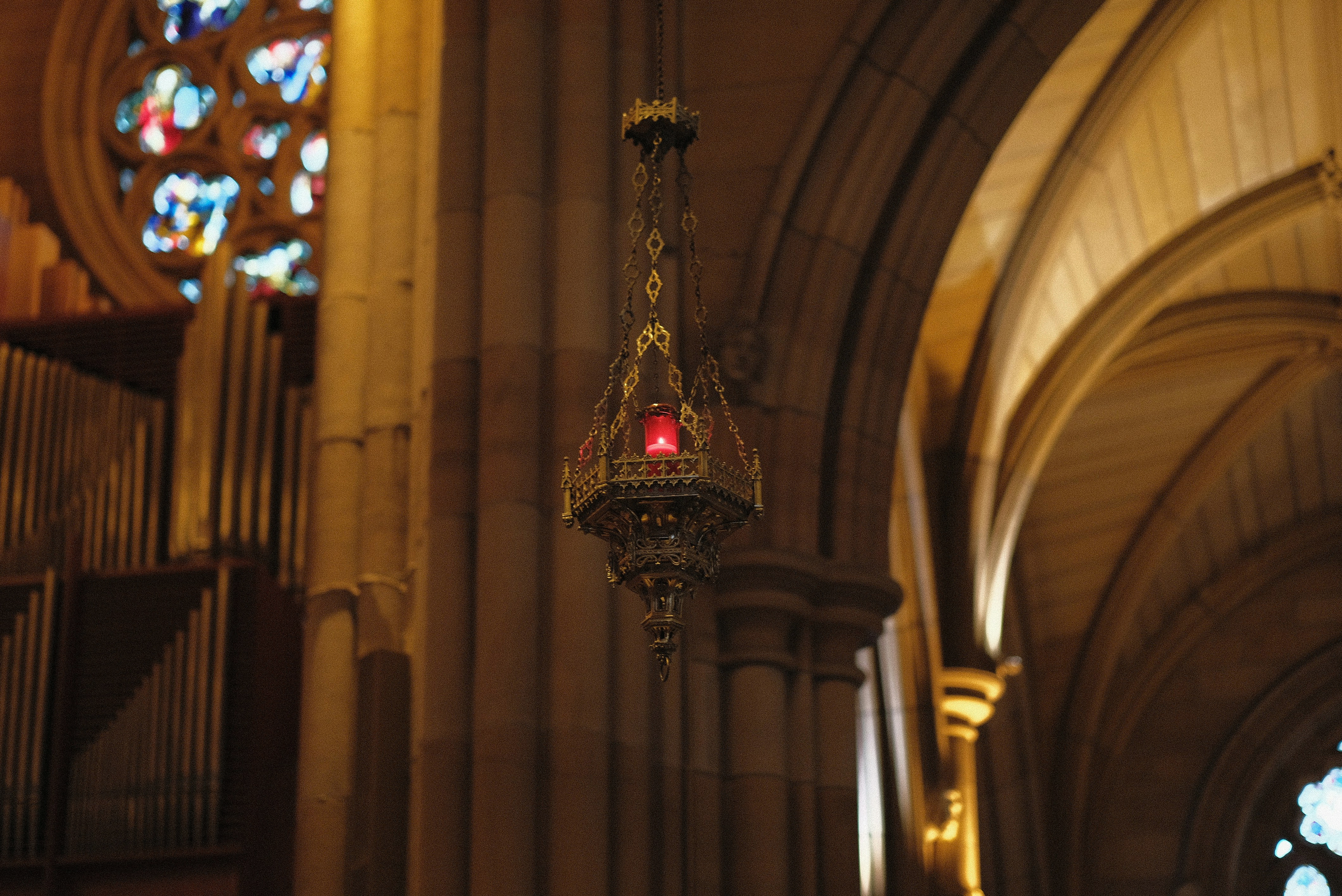 Crimson Lantern Adrift Between Gothic Arches