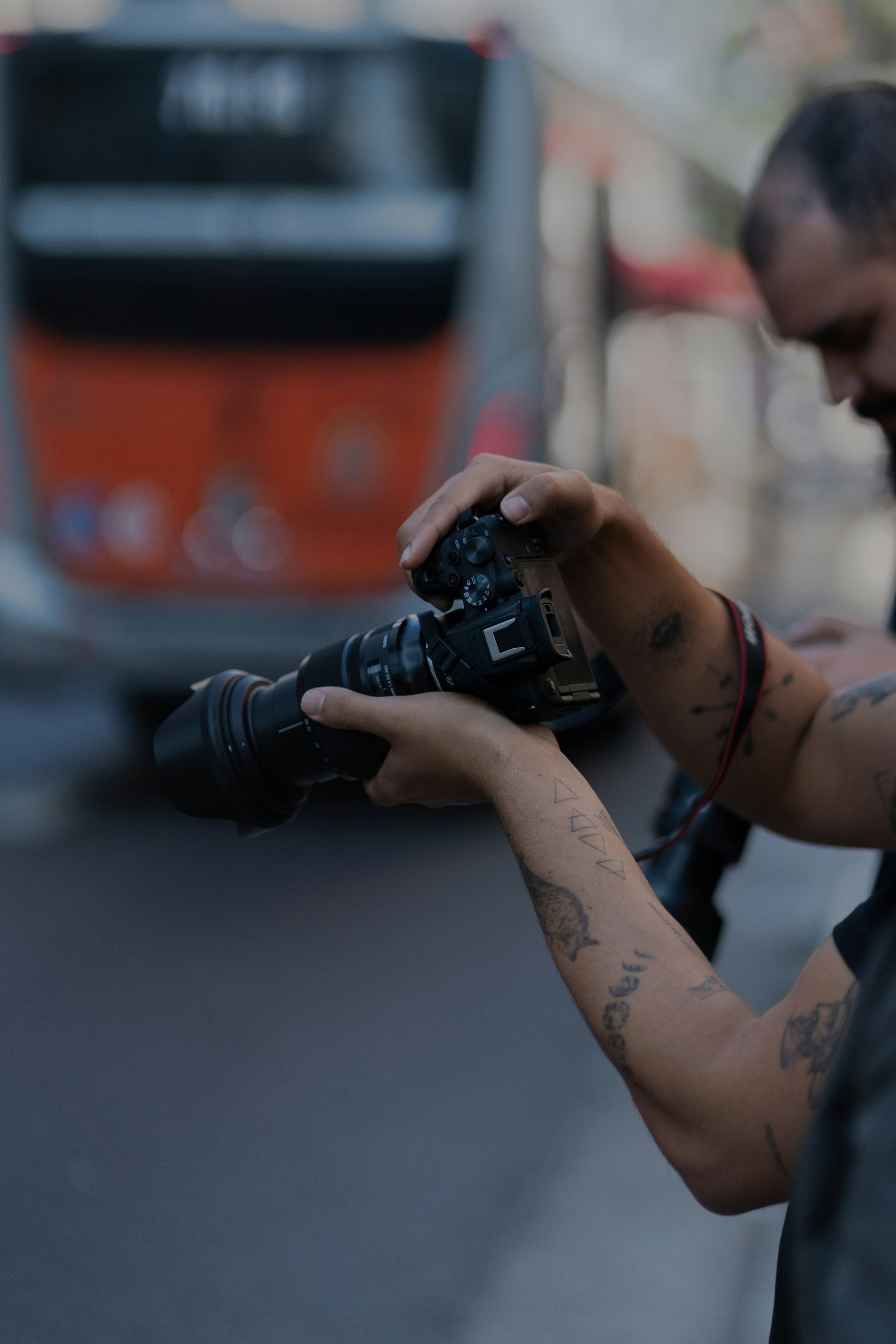 Tattooed Hands on the Street: The Photographer’s Grip with a Telephoto Lens