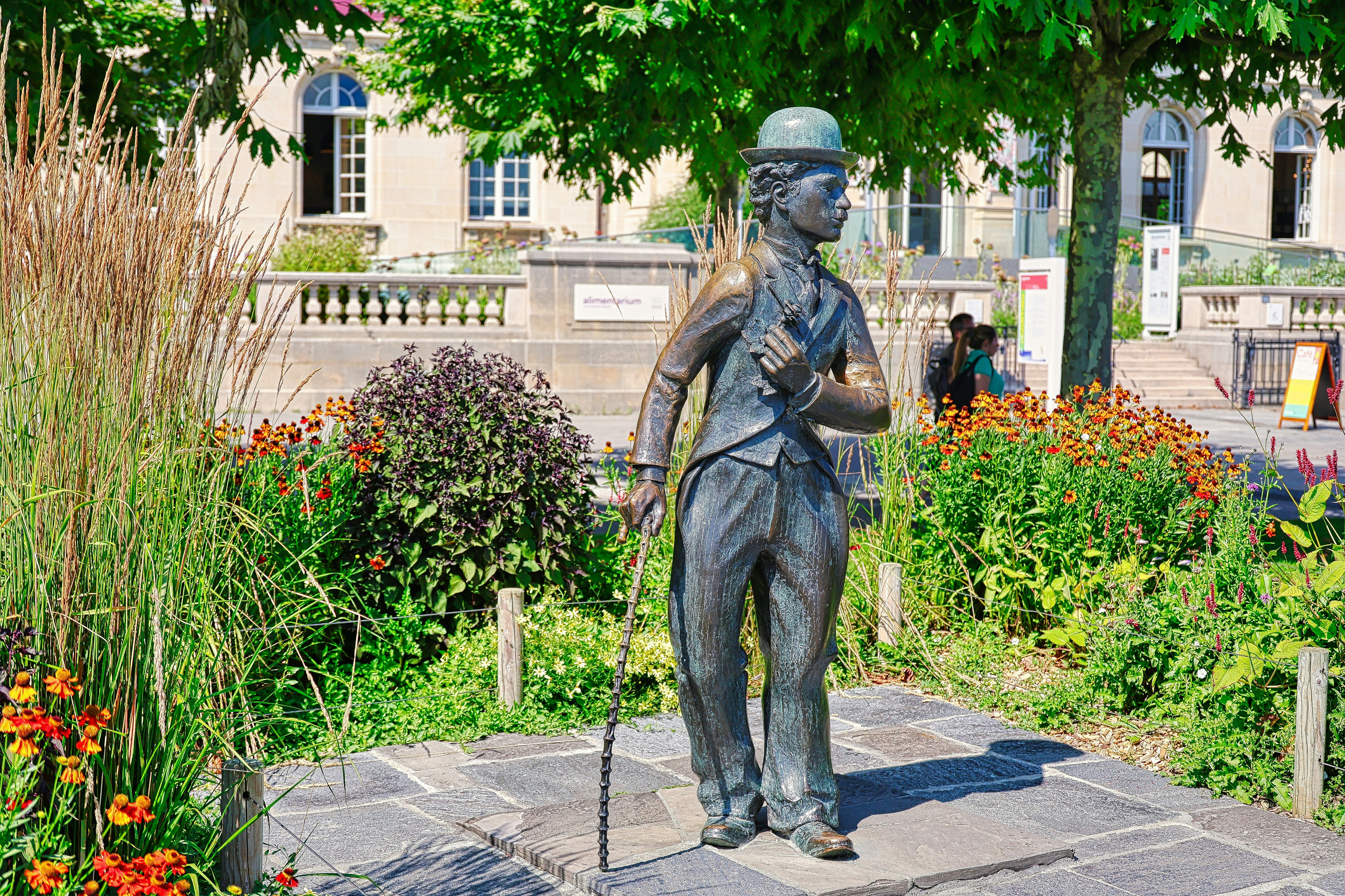 A statue of a man holding a cane photo – Free Vevey Image on Unsplash
