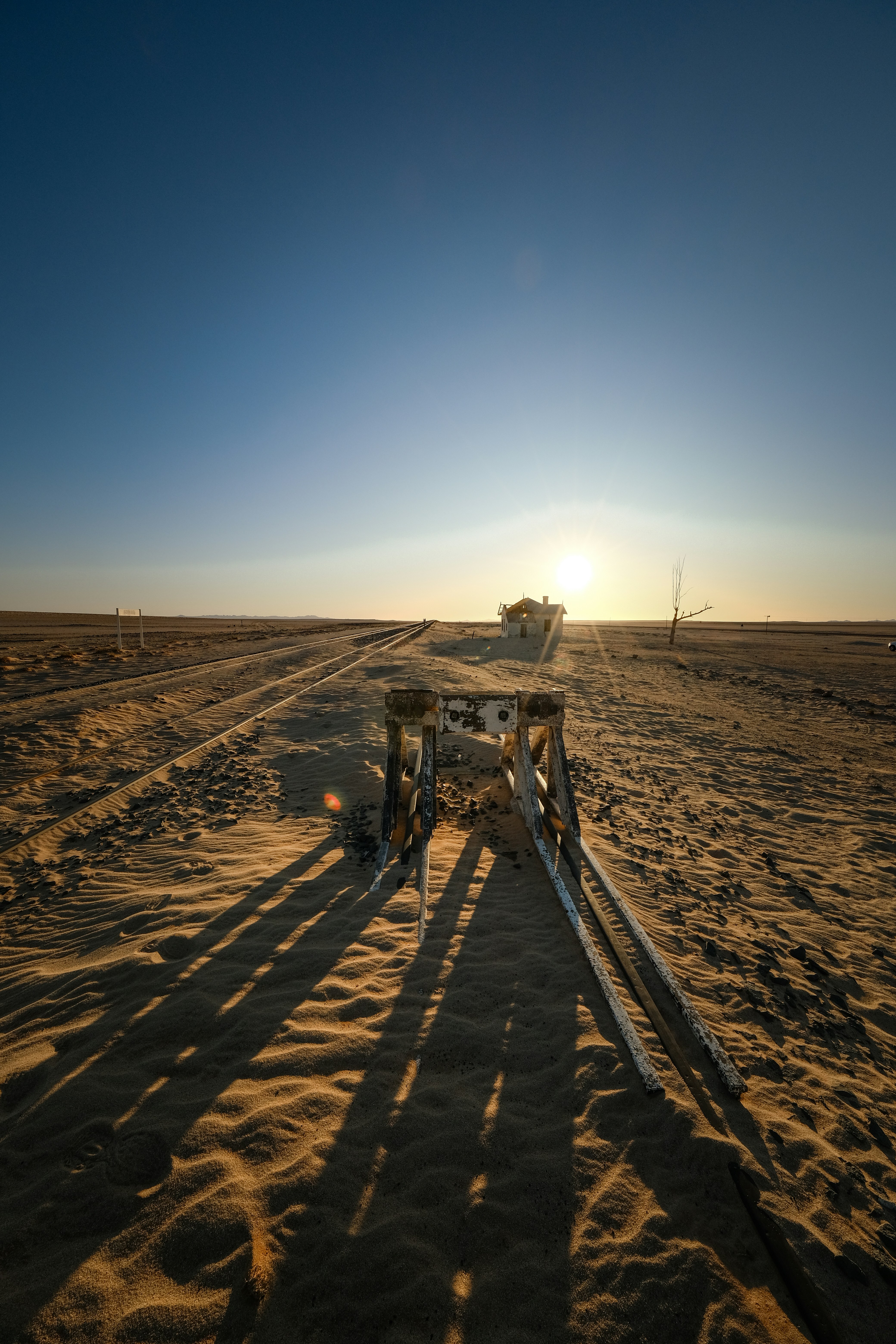 Sunset Rails: A Desolate Outpost Basks on the Horizon