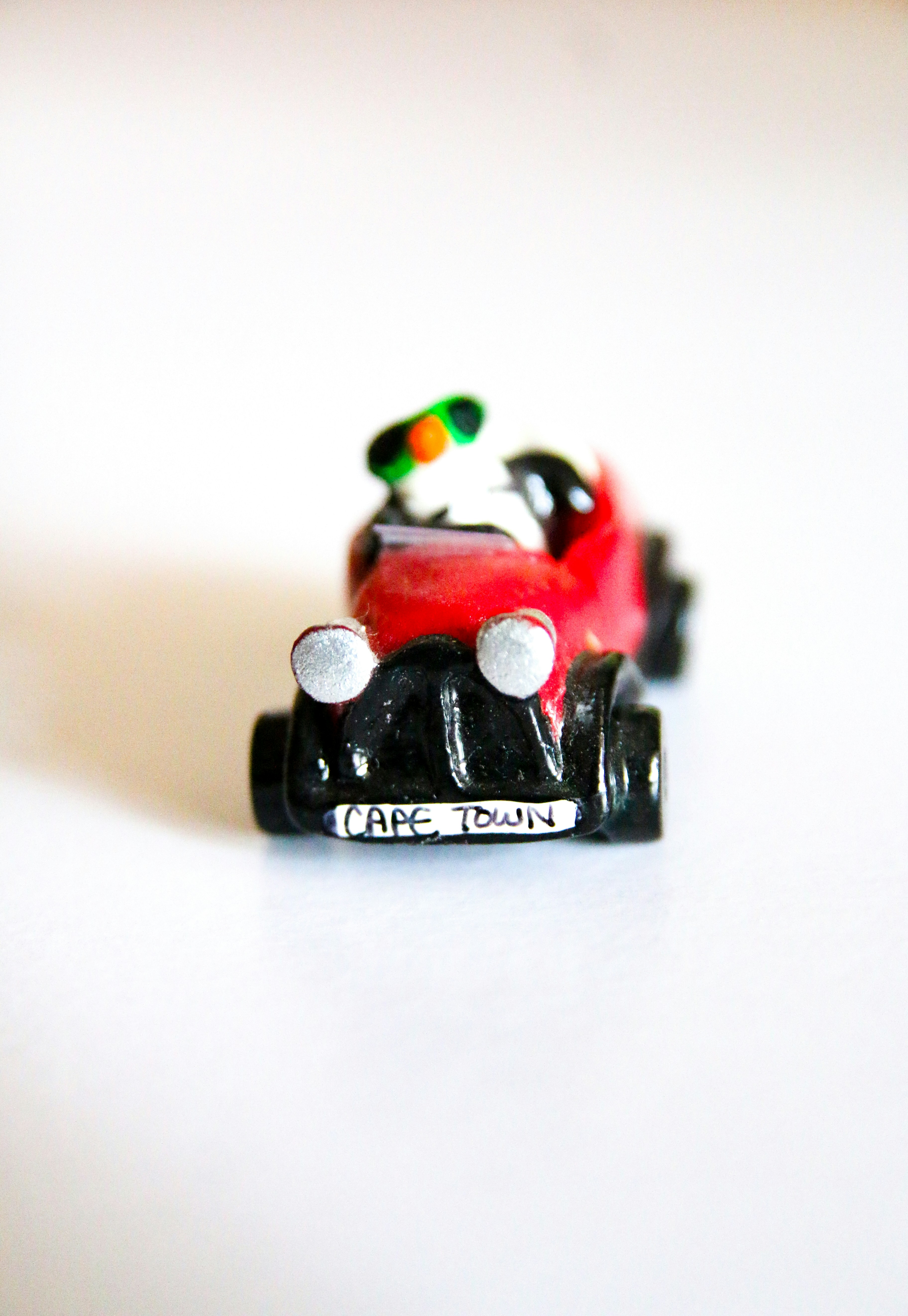 Cape Town Racer: A Tiny Toy Car in Focus on a Clean White Stage