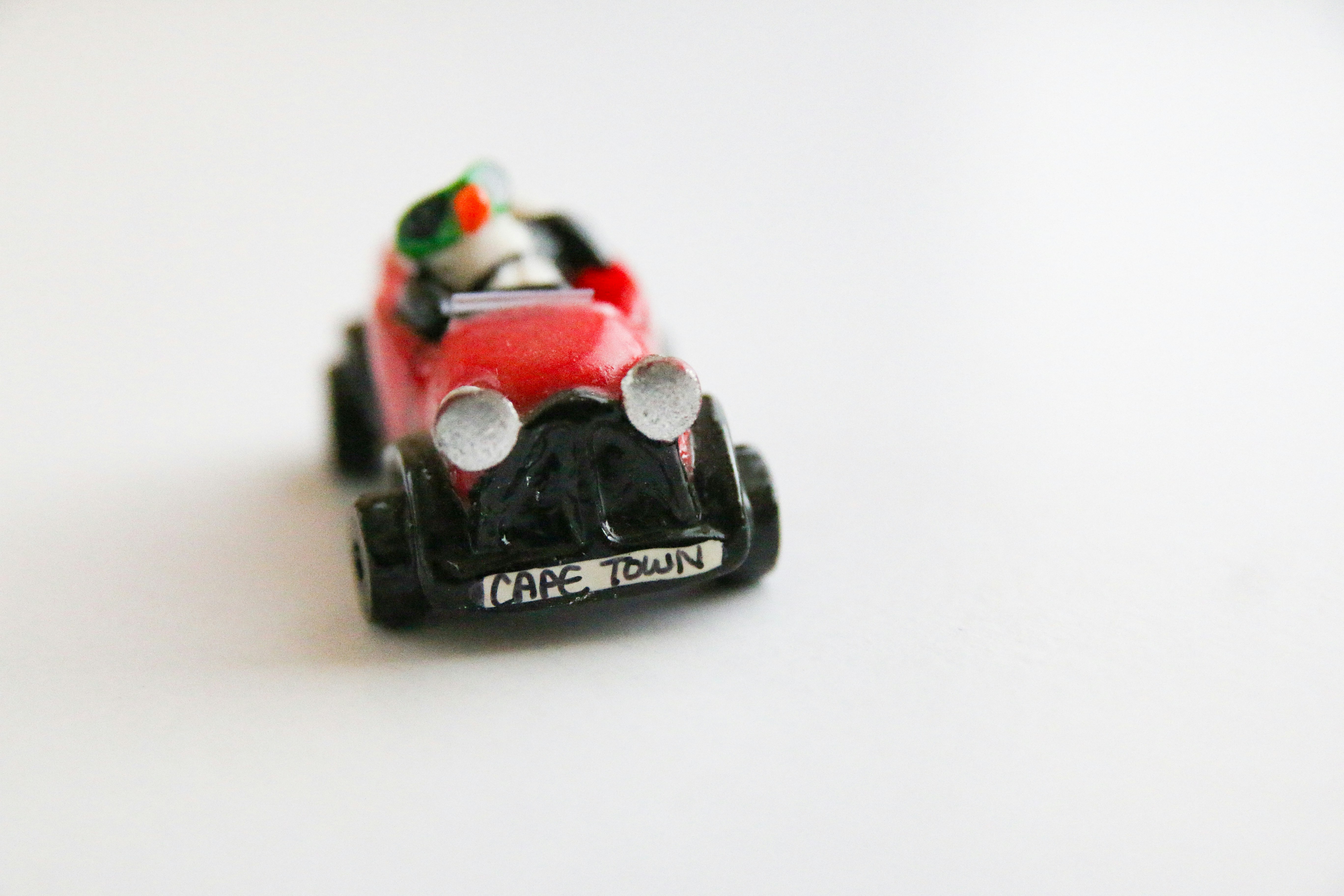 Micro Red Roadster on a Crisp White Stage