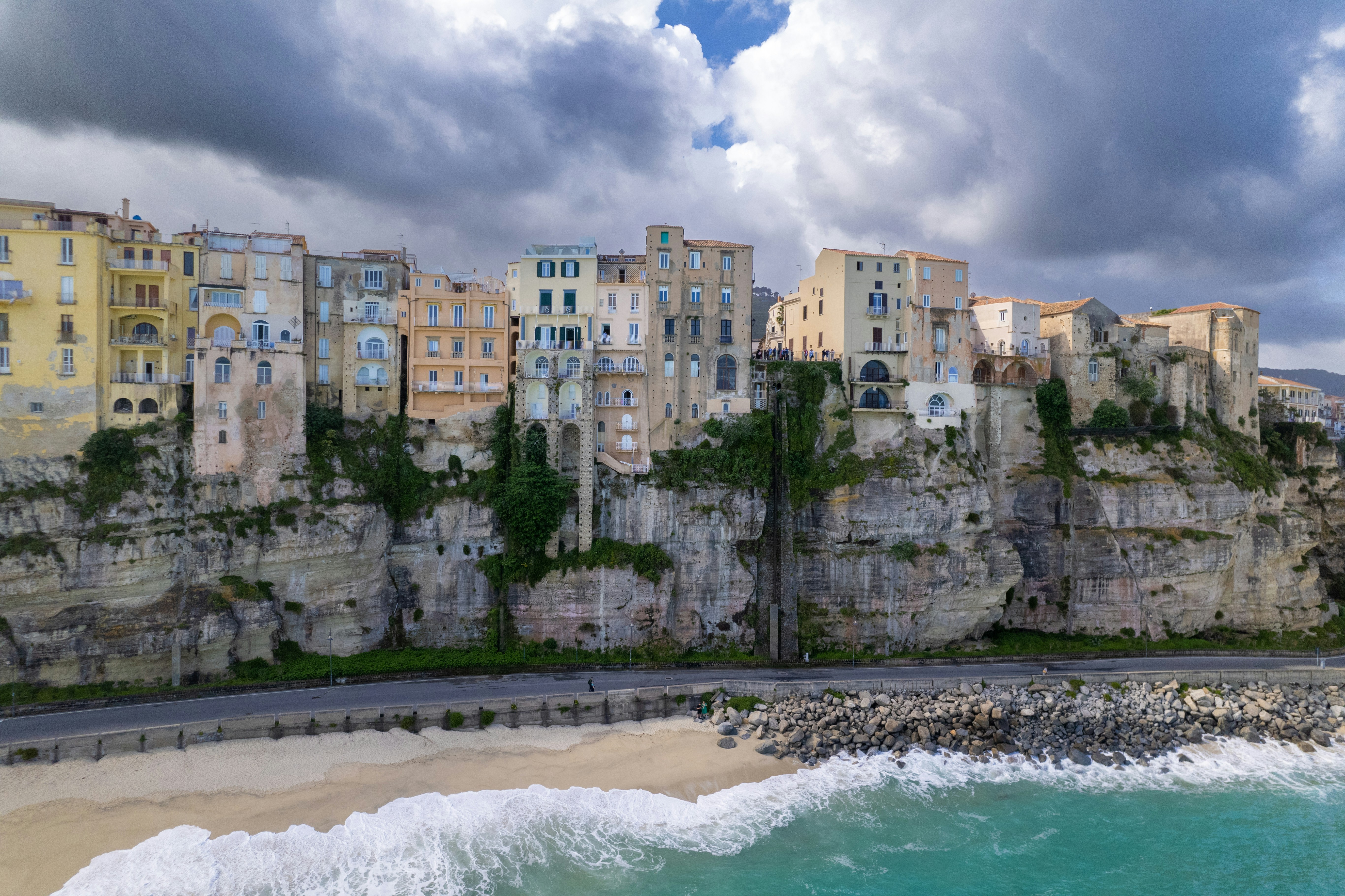 A view of a beach with buildings on the cliff photo – Free Tropea Image ...