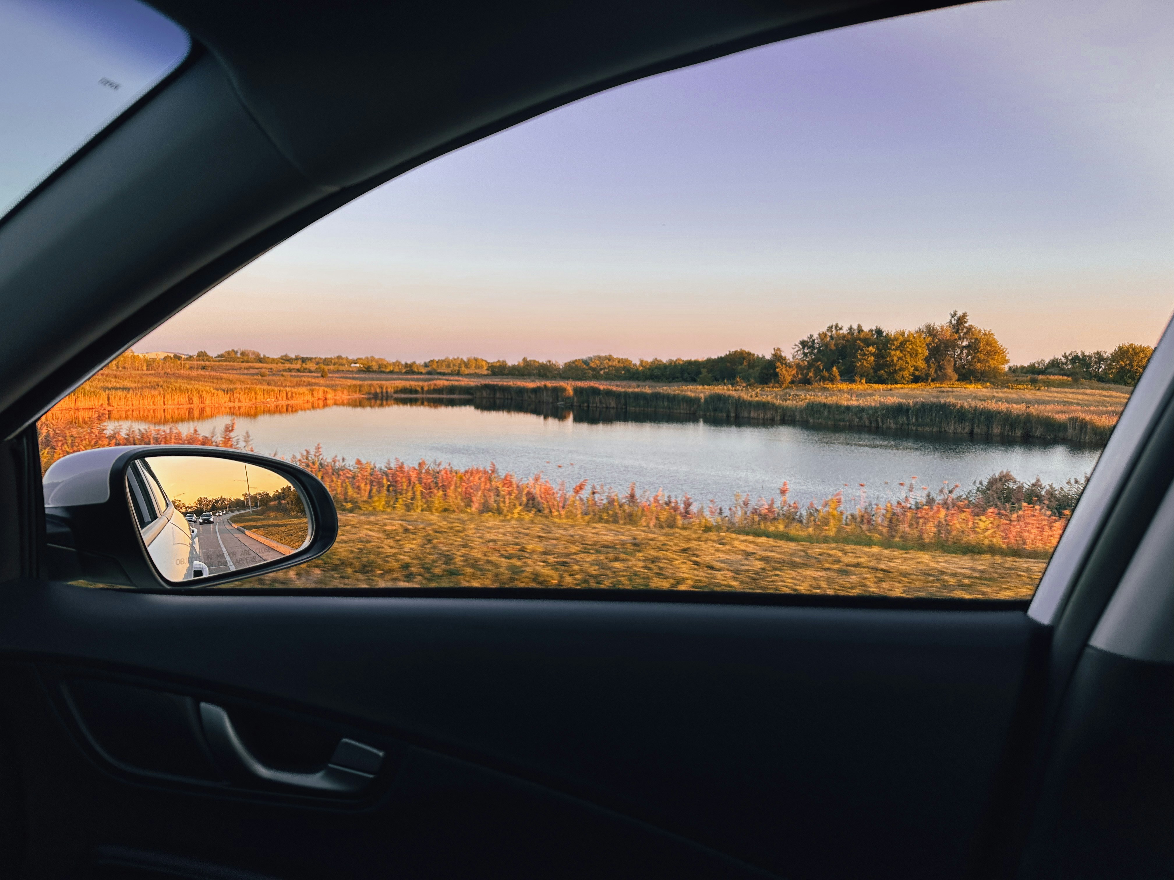 Golden Hour Riverscape Framed by a Car Window