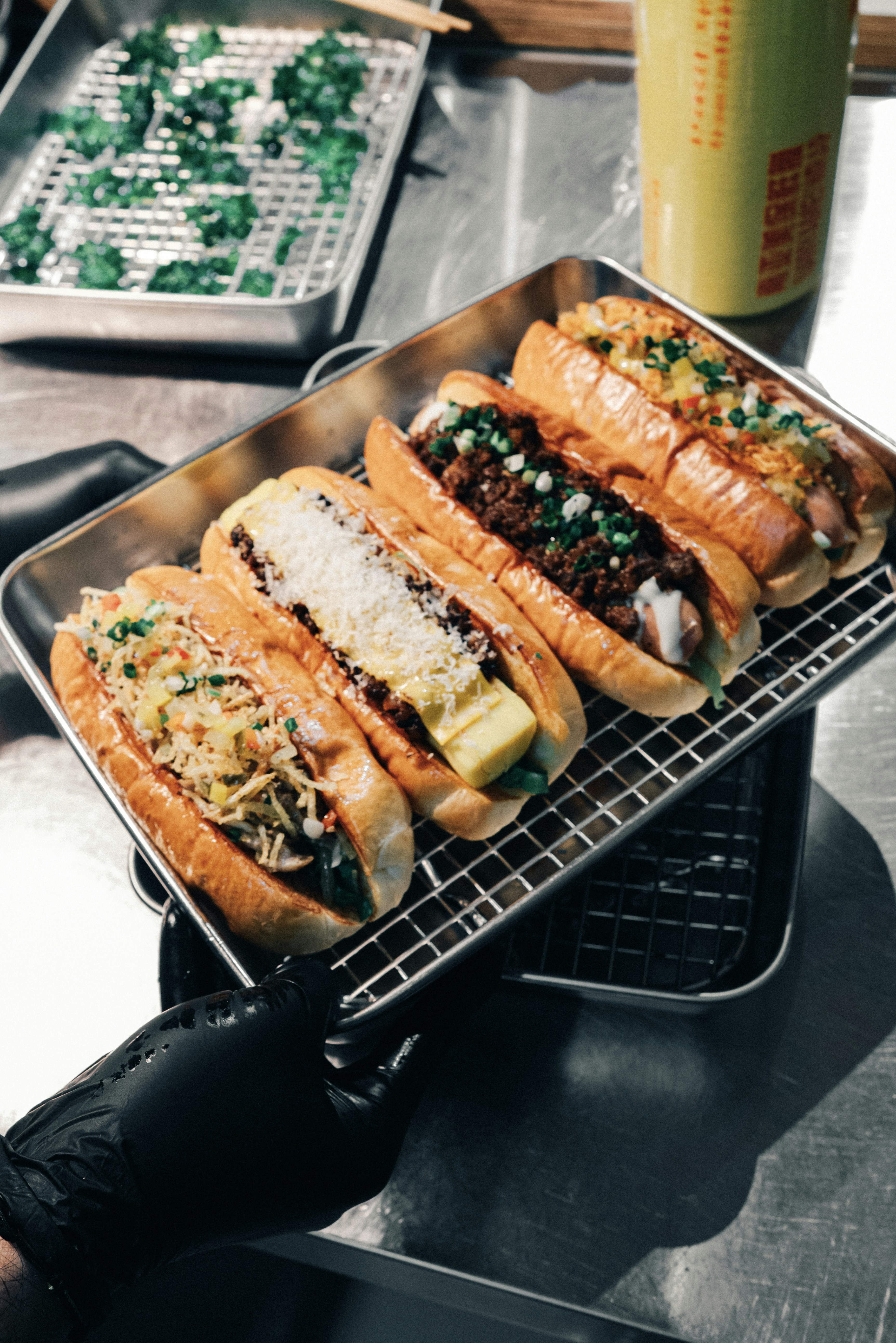 Tray of Gourmet Hot Dogs on a Stainless Steel Prep Station