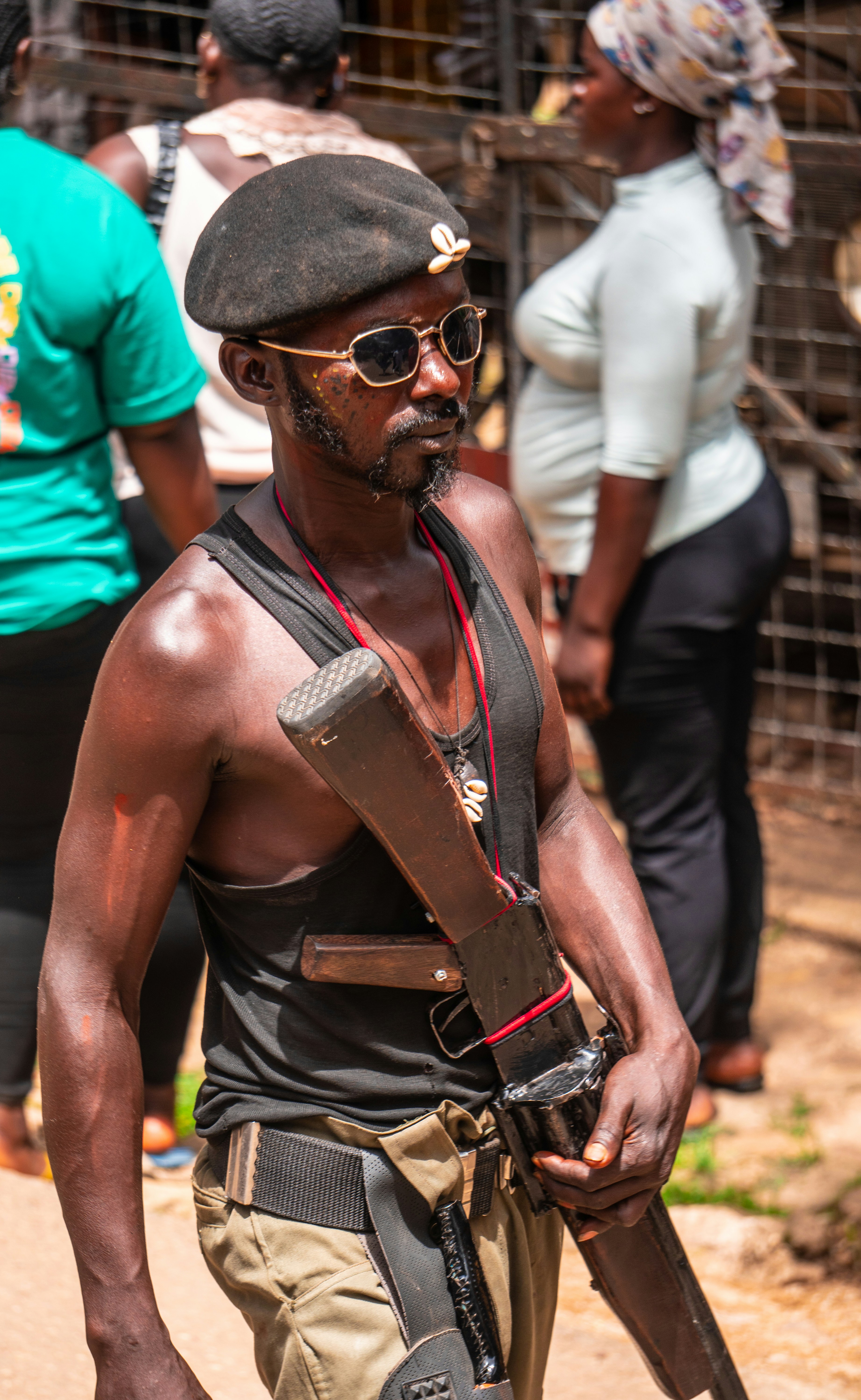 Beret-Wearing Sentinel: Street Portrait with a Slung Rifle