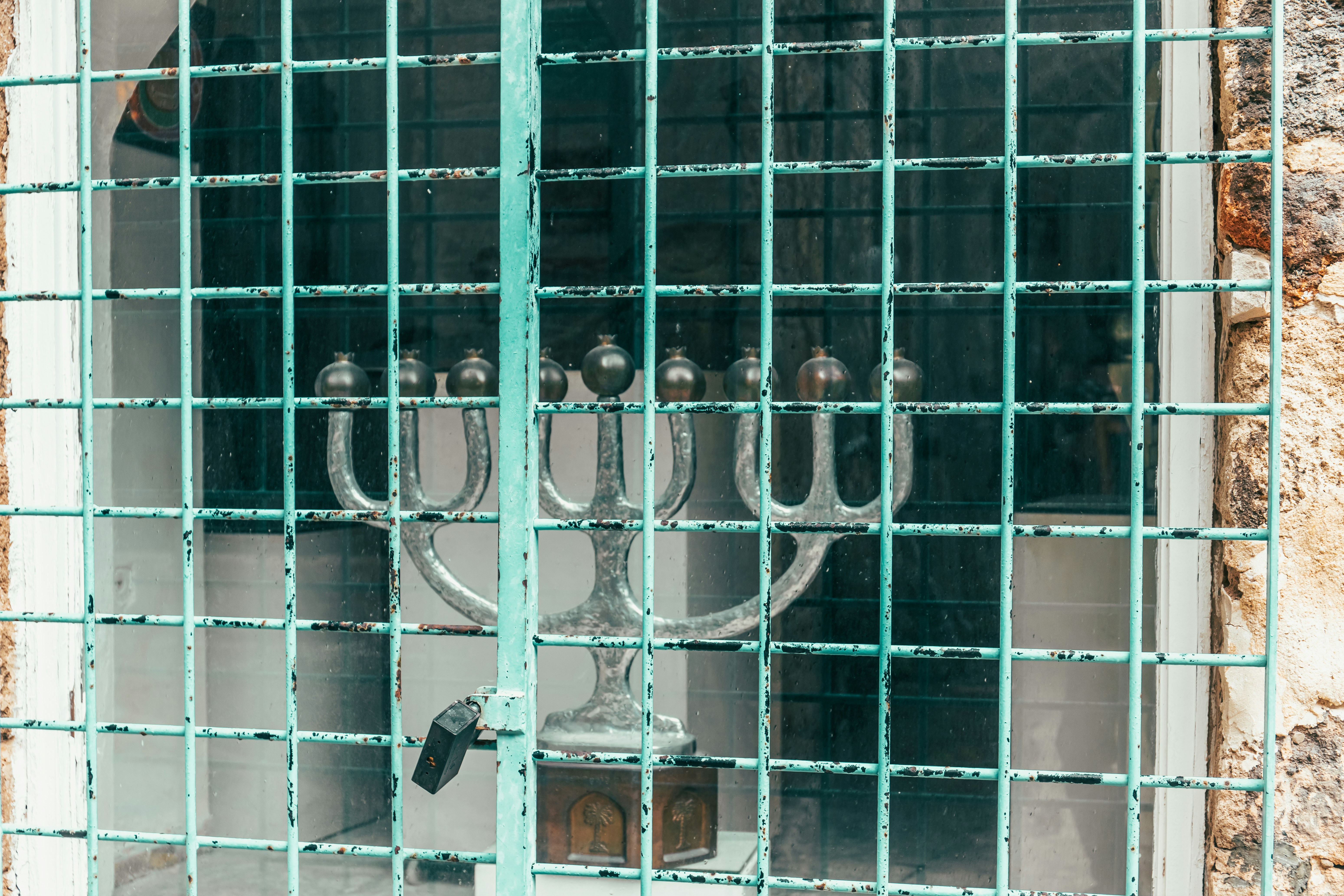 Locked Glee: A teal grate frames a chrome candlestick-style lockbox