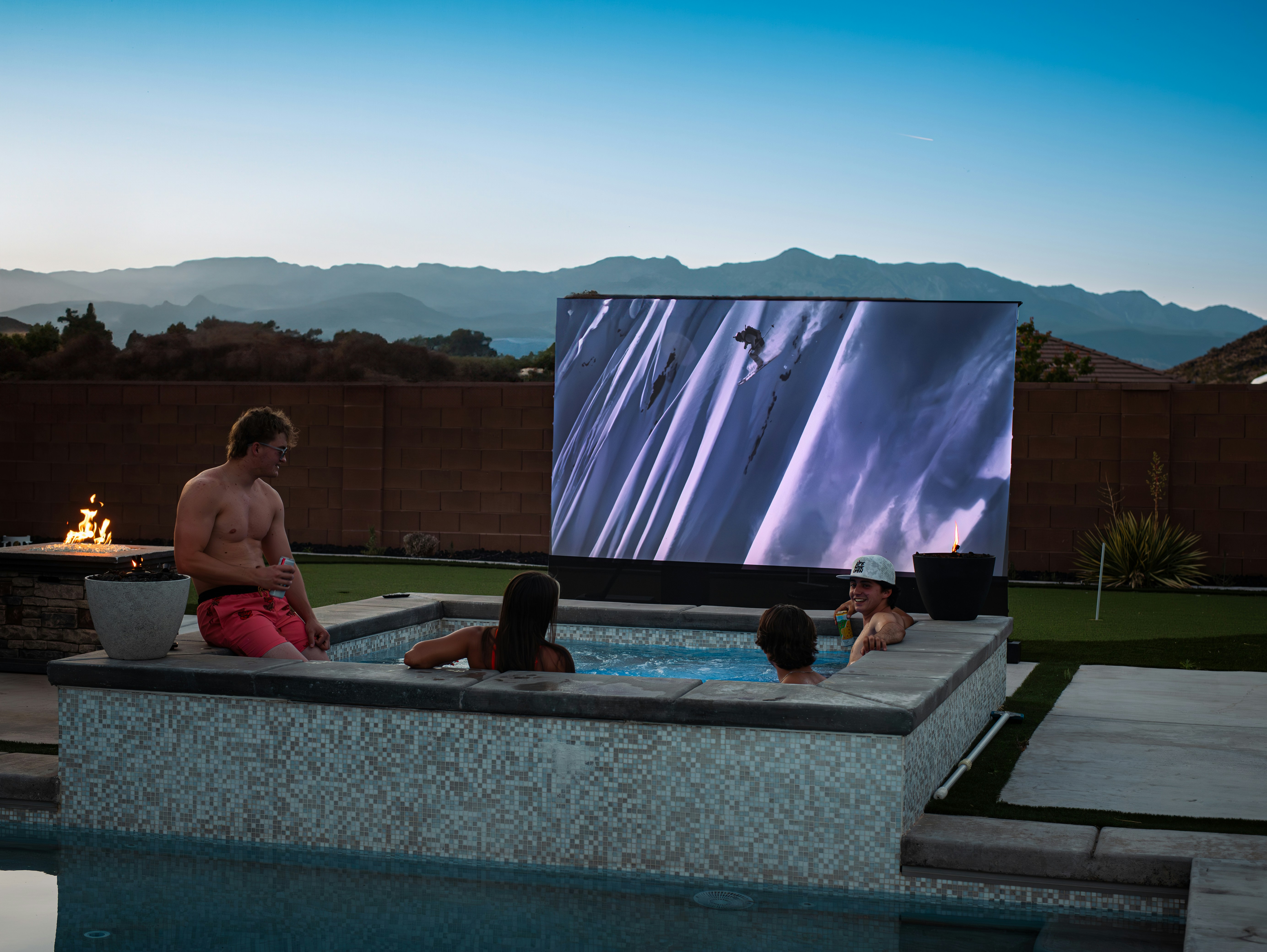 A group of people sitting around a hot tub photo – Free Ust projector ...