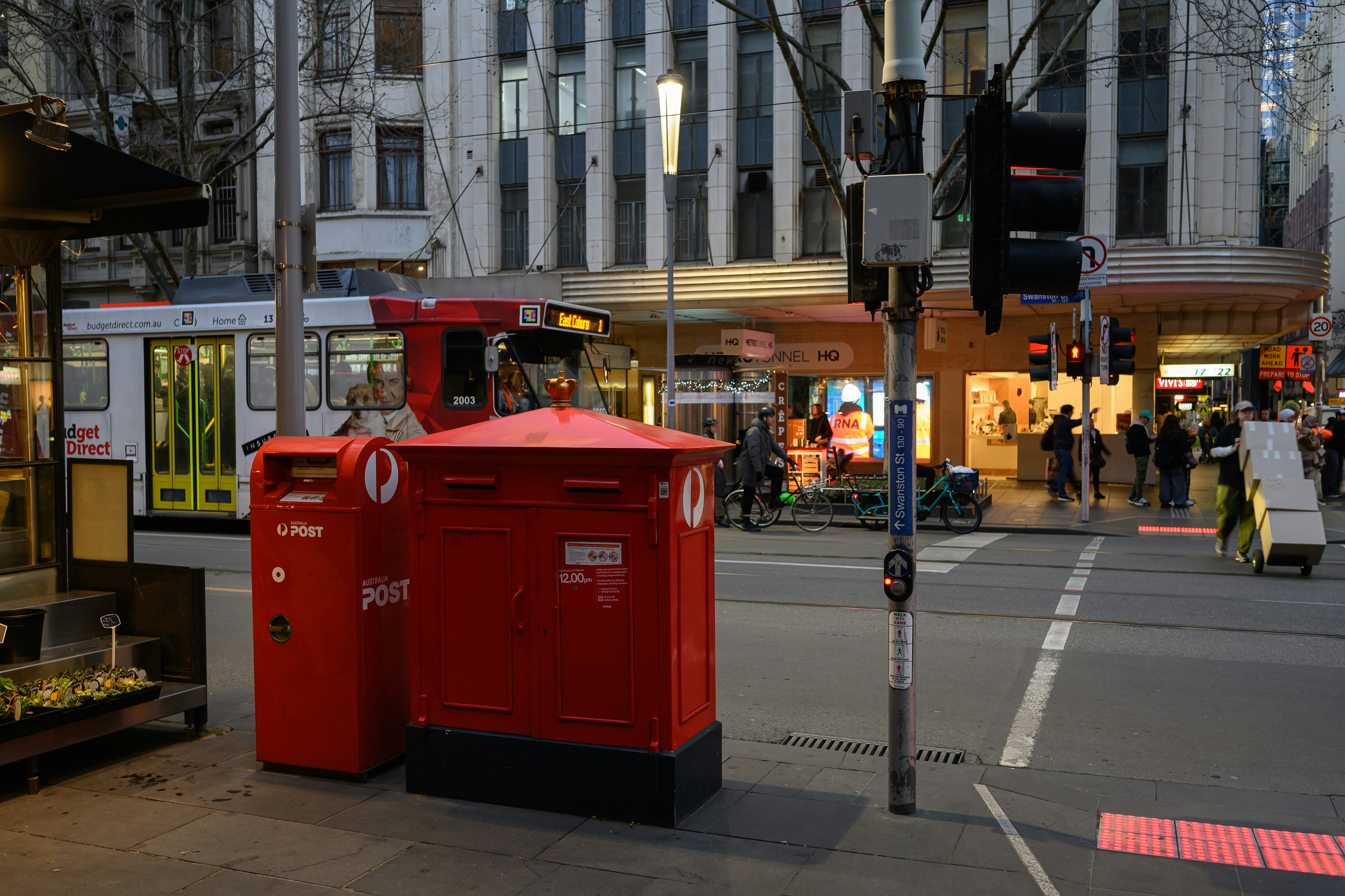 Red Mailboxes Guard a Quiet City Crossing