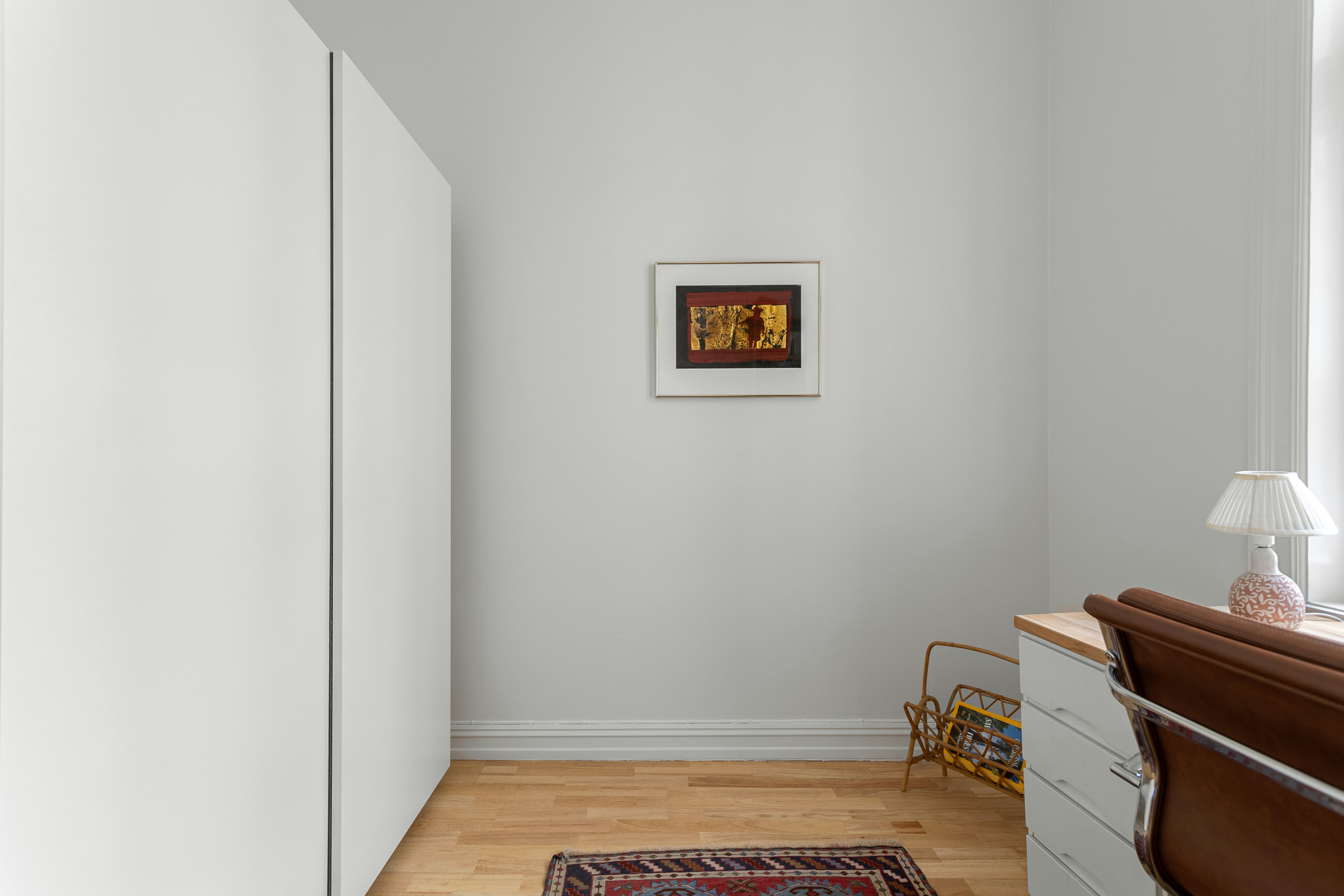 Framed Quiet: A Minimalist Nook with Light and Leather