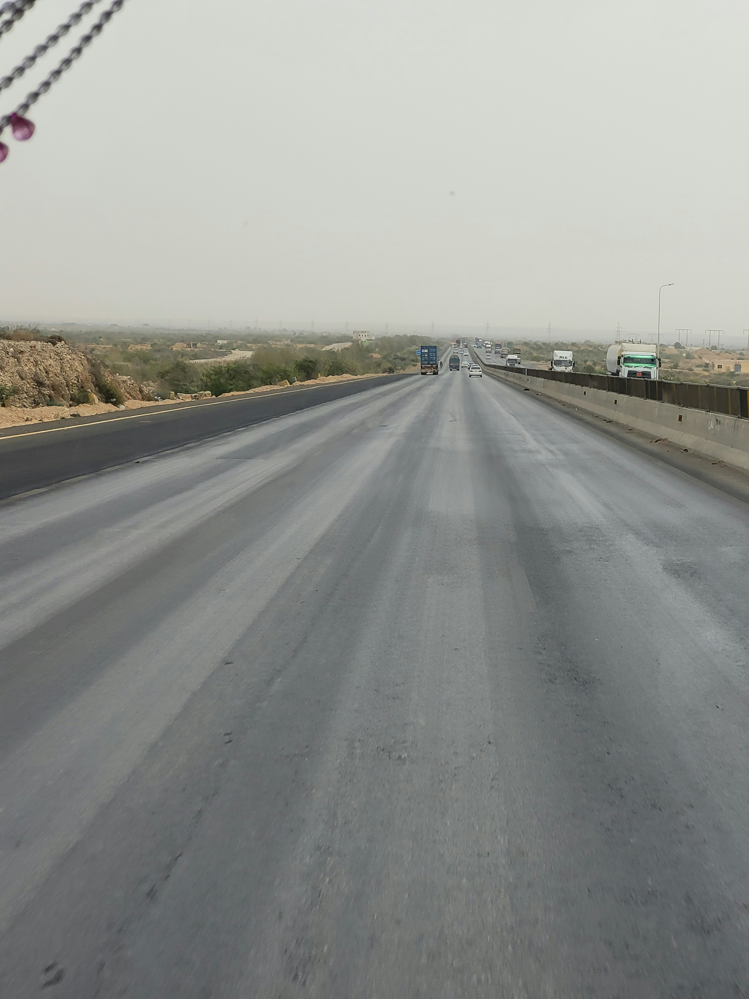Vanishing Lane: Desert Highway to a Hazy Horizon