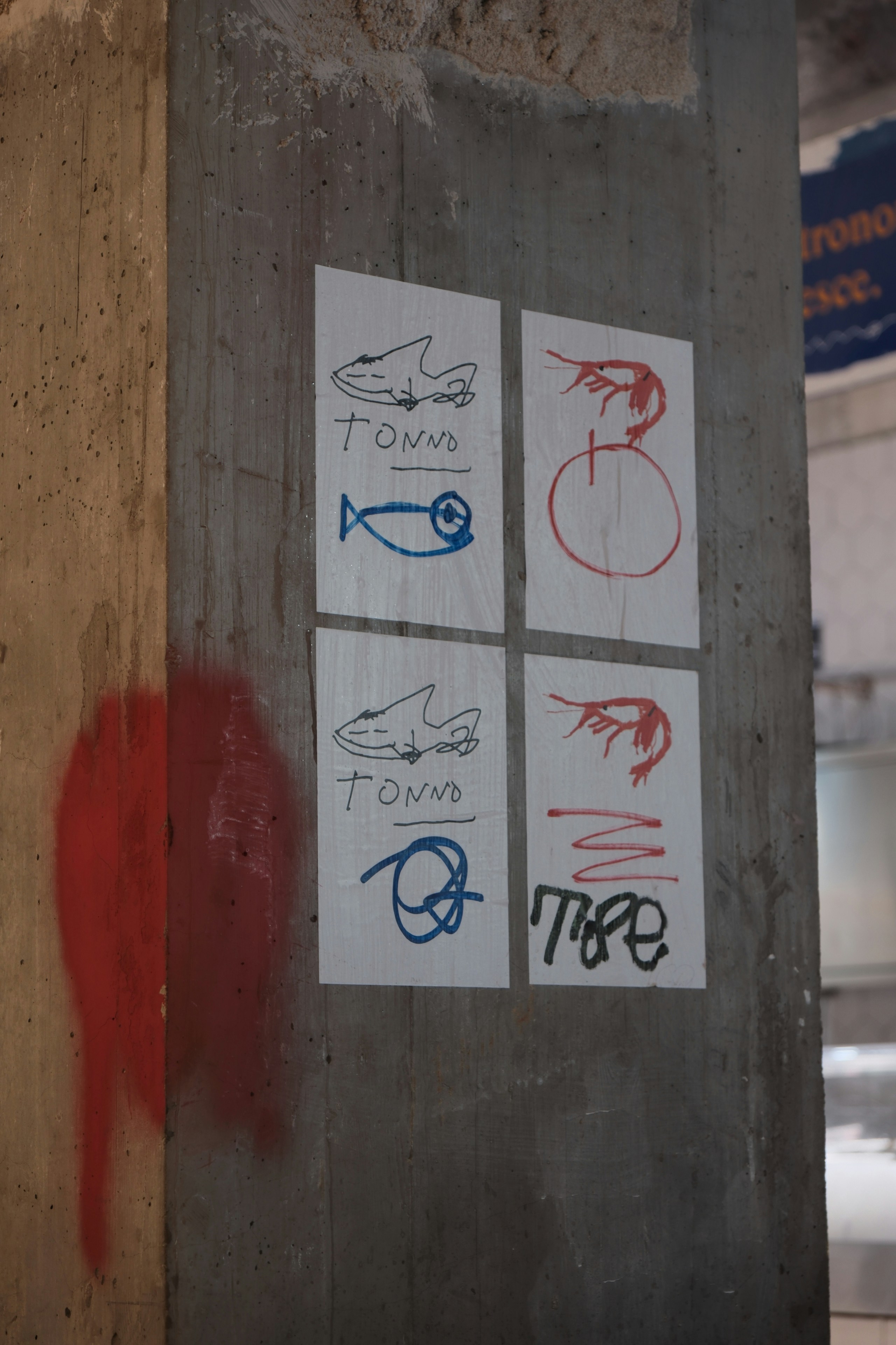 Quad Sticker Sketches on a Weathered Concrete Pillar