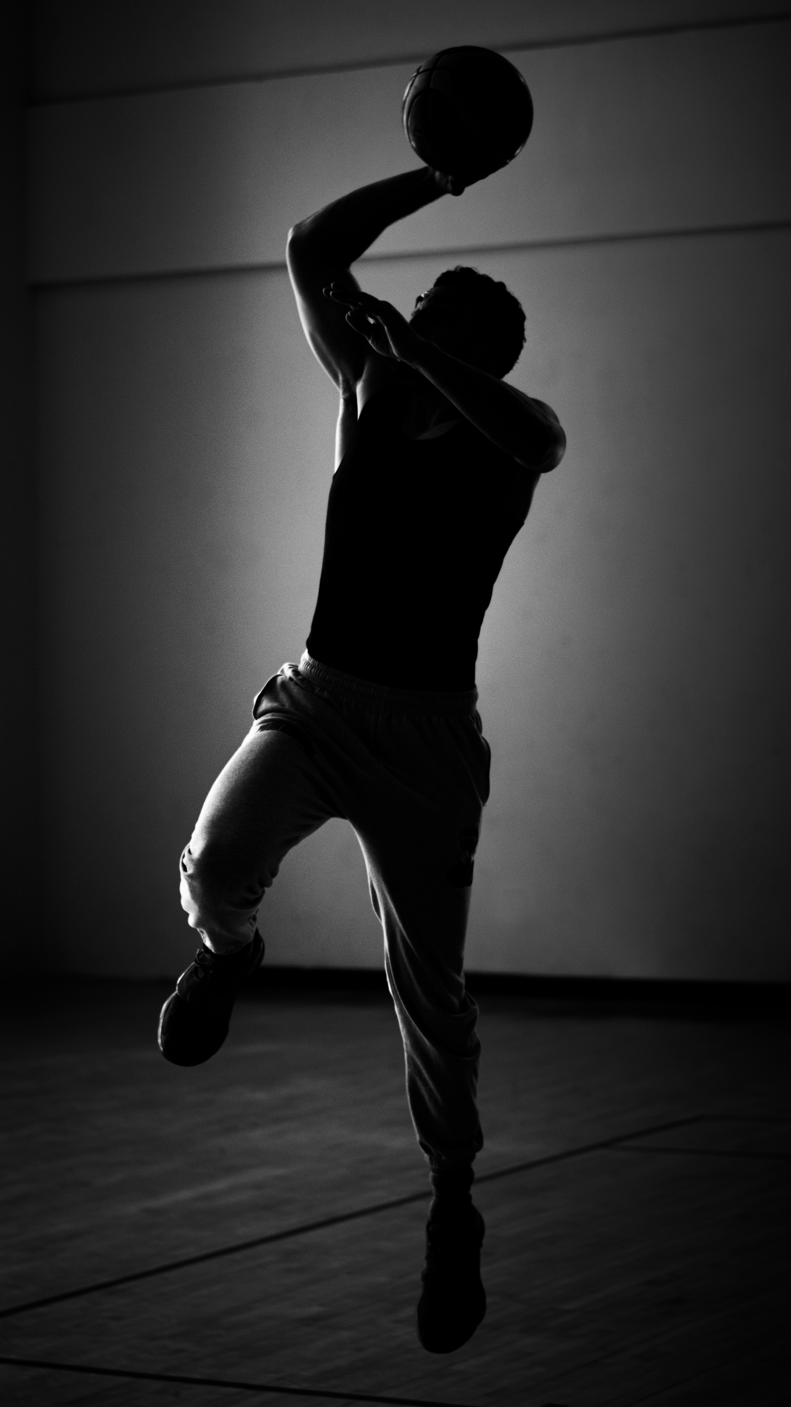 Noir Flight: Silhouette of a Basketball Player in Midair