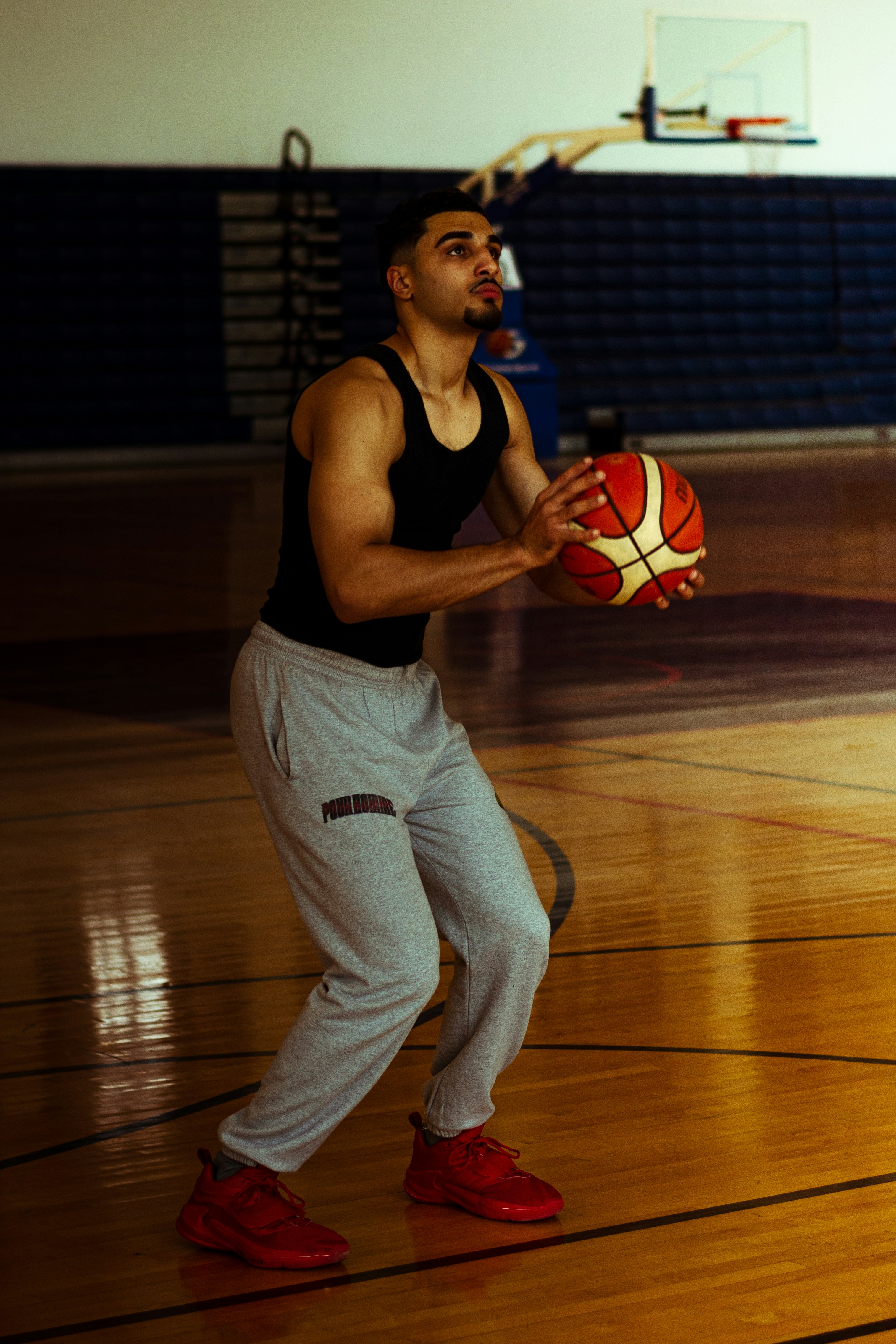 Focused Drill: A Player Secures the Ball in a Quiet Gym