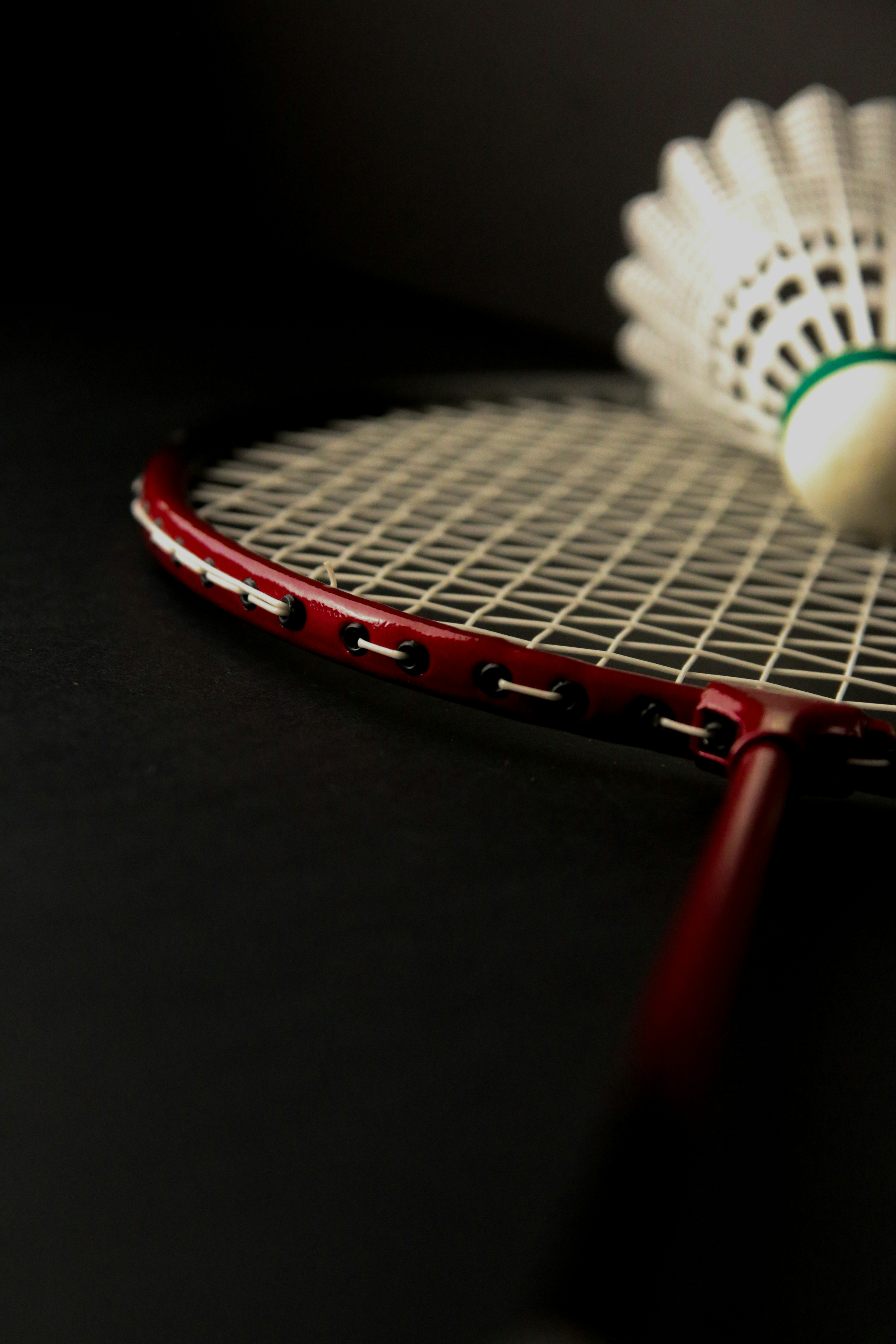 Crimson Racket Edge in Focus with Shuttlecock Blur