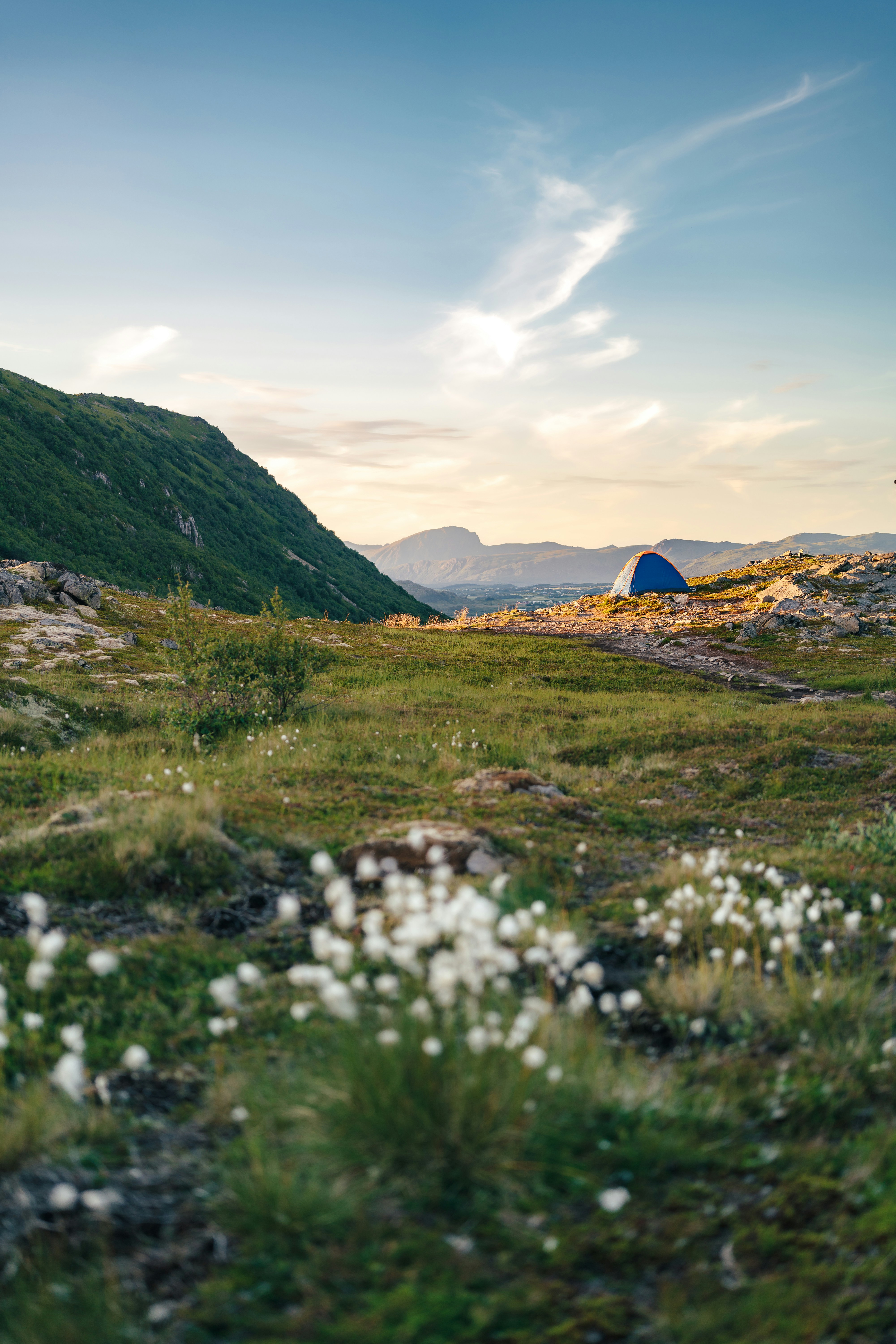 Blue Tent on a Wind-Washed Highland Meadow at Sunset