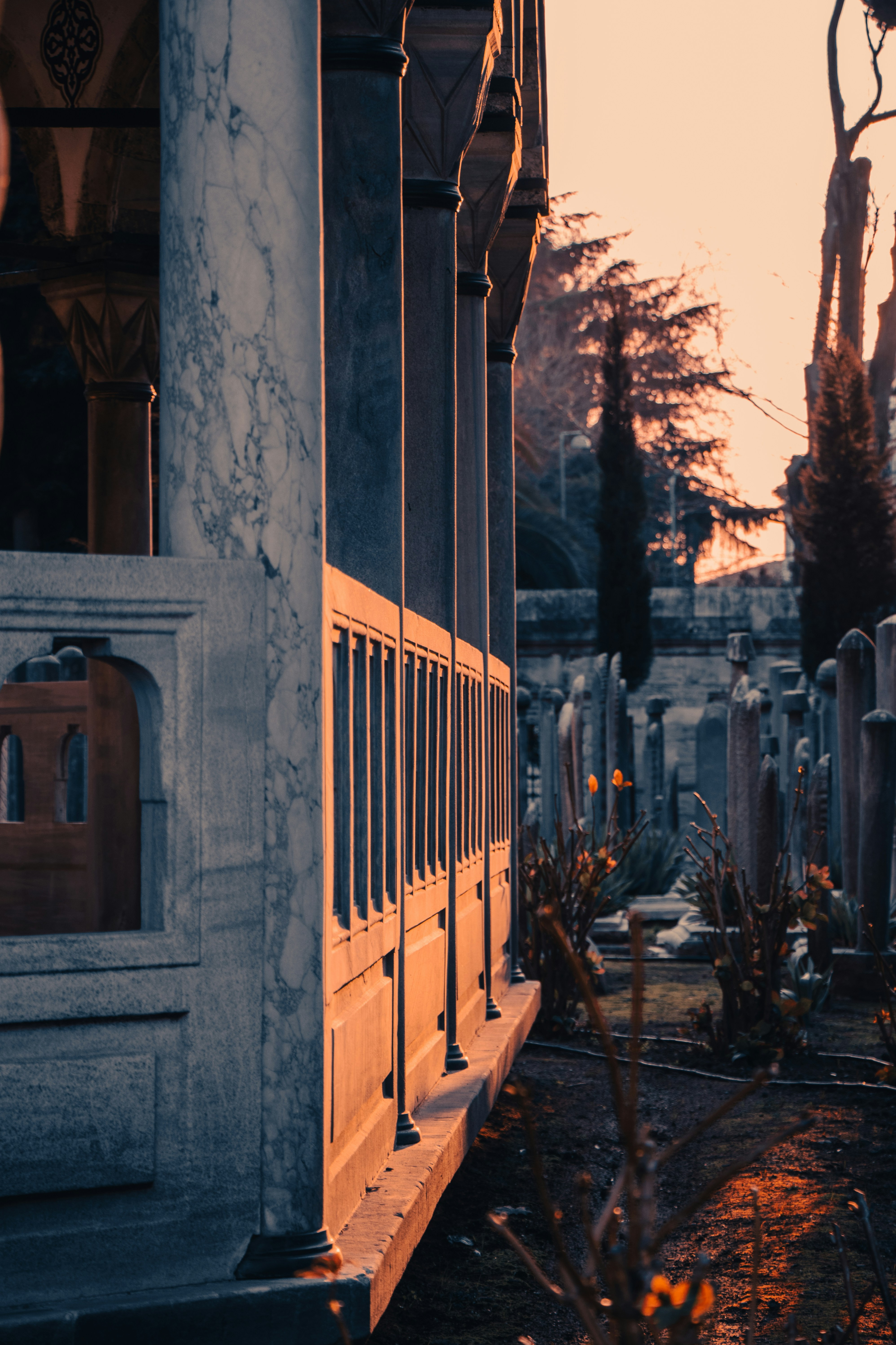 Sunlit Colonnade by the Cemetery: Marble Columns Dressed in Dusk