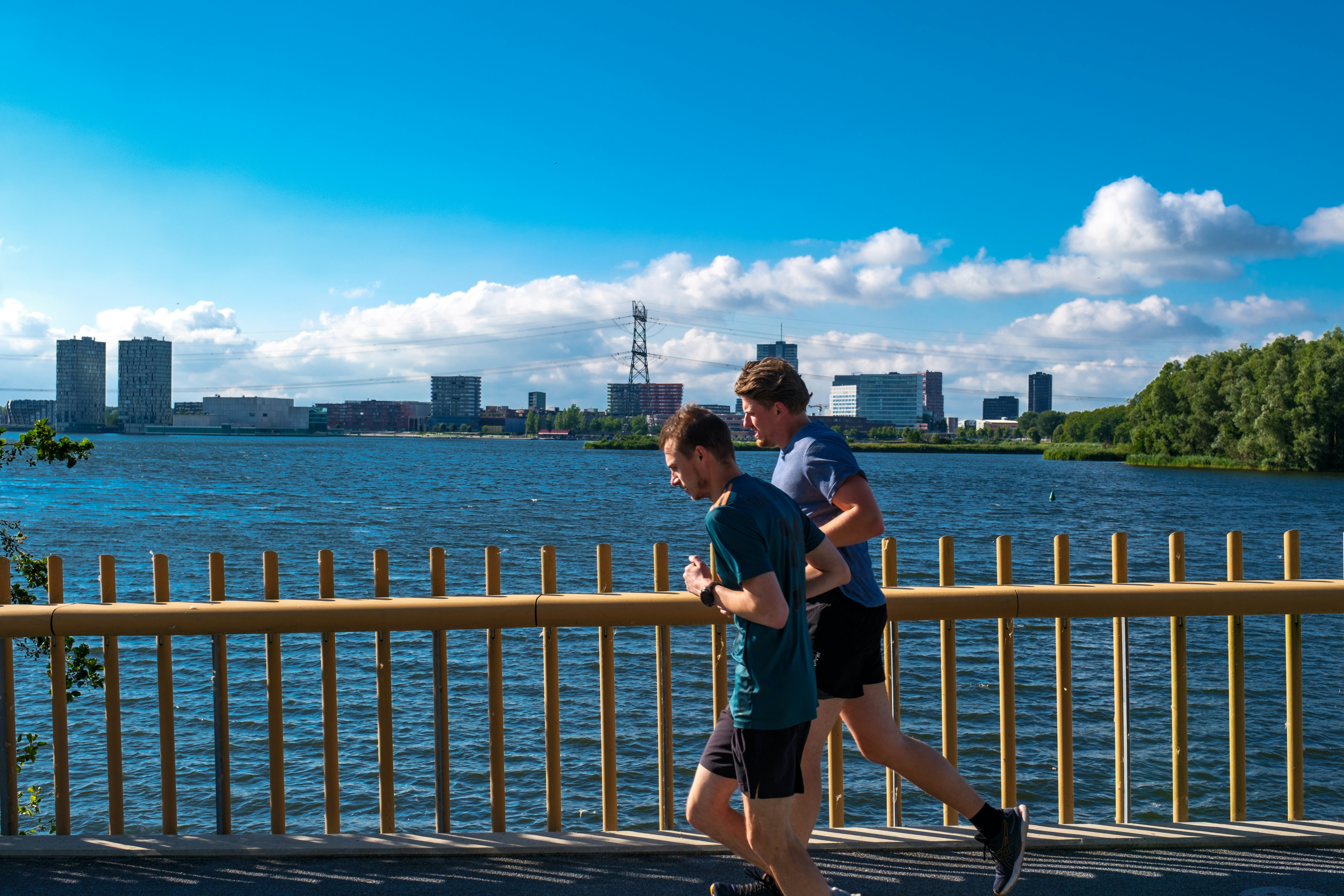 A couple of people that are running across a bridge photo – Free Man ...
