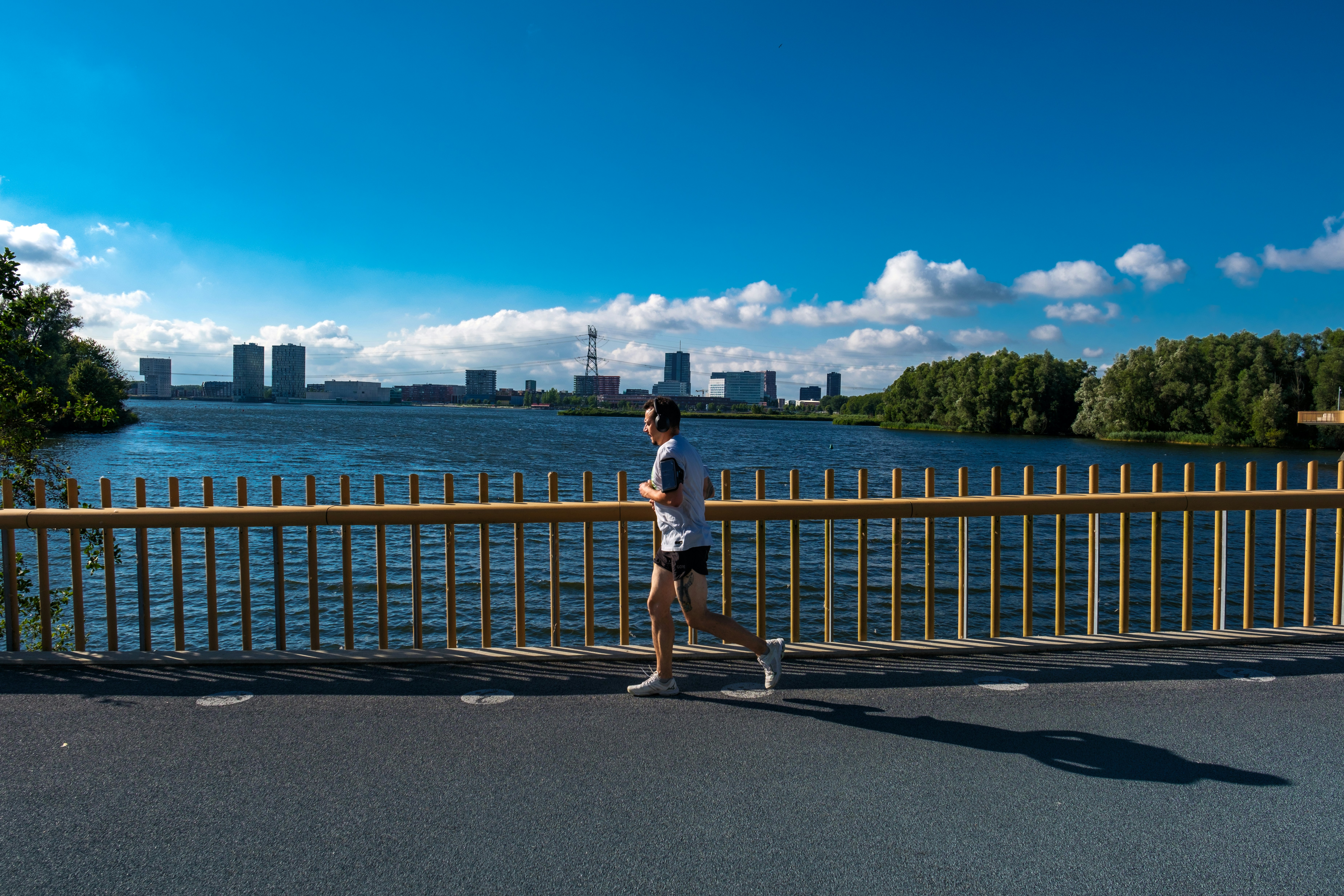 A man running across a bridge over a river photo – Free Adult Image on ...