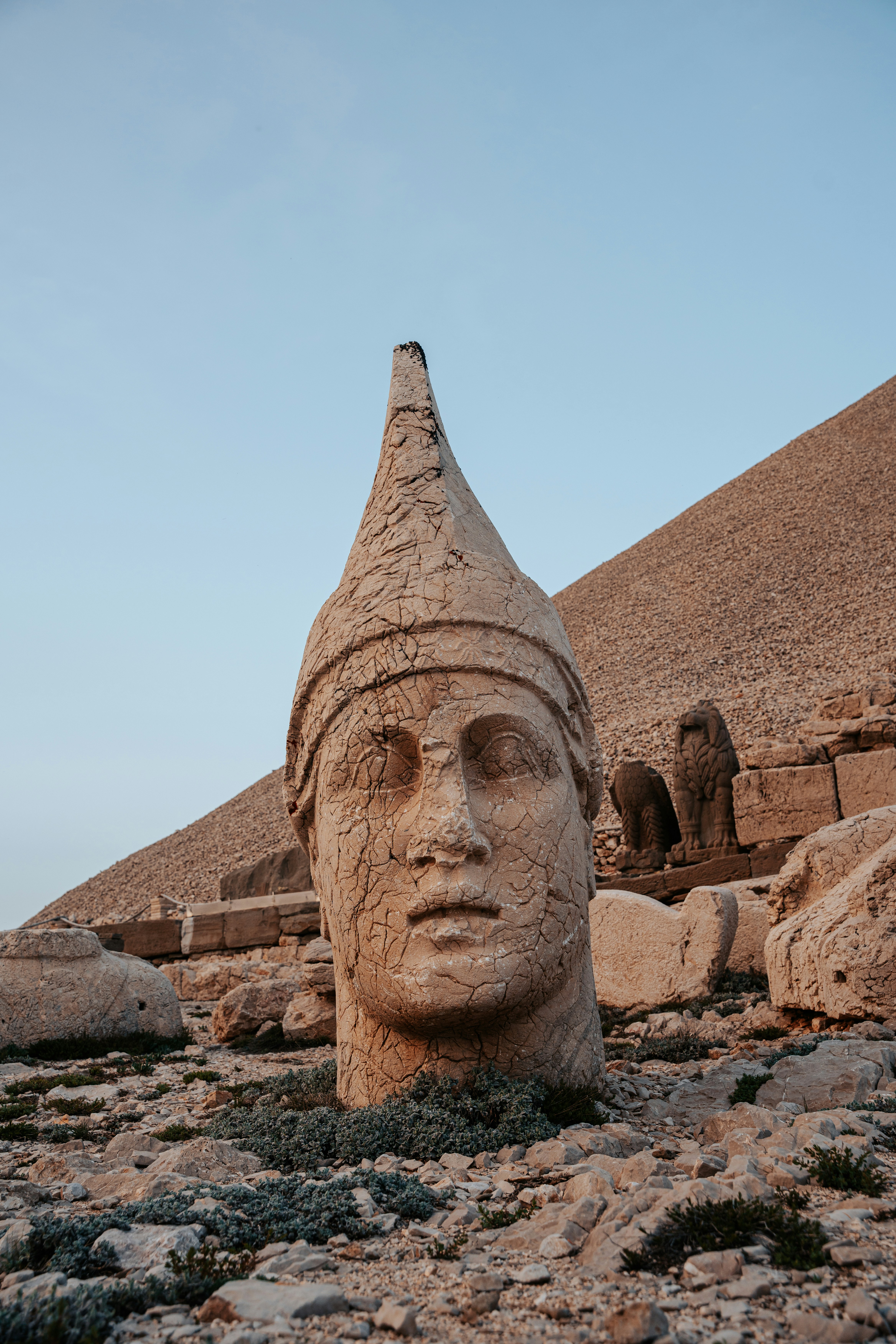 A statue of a head in front of a pyramid photo – Free Man Image on Unsplash