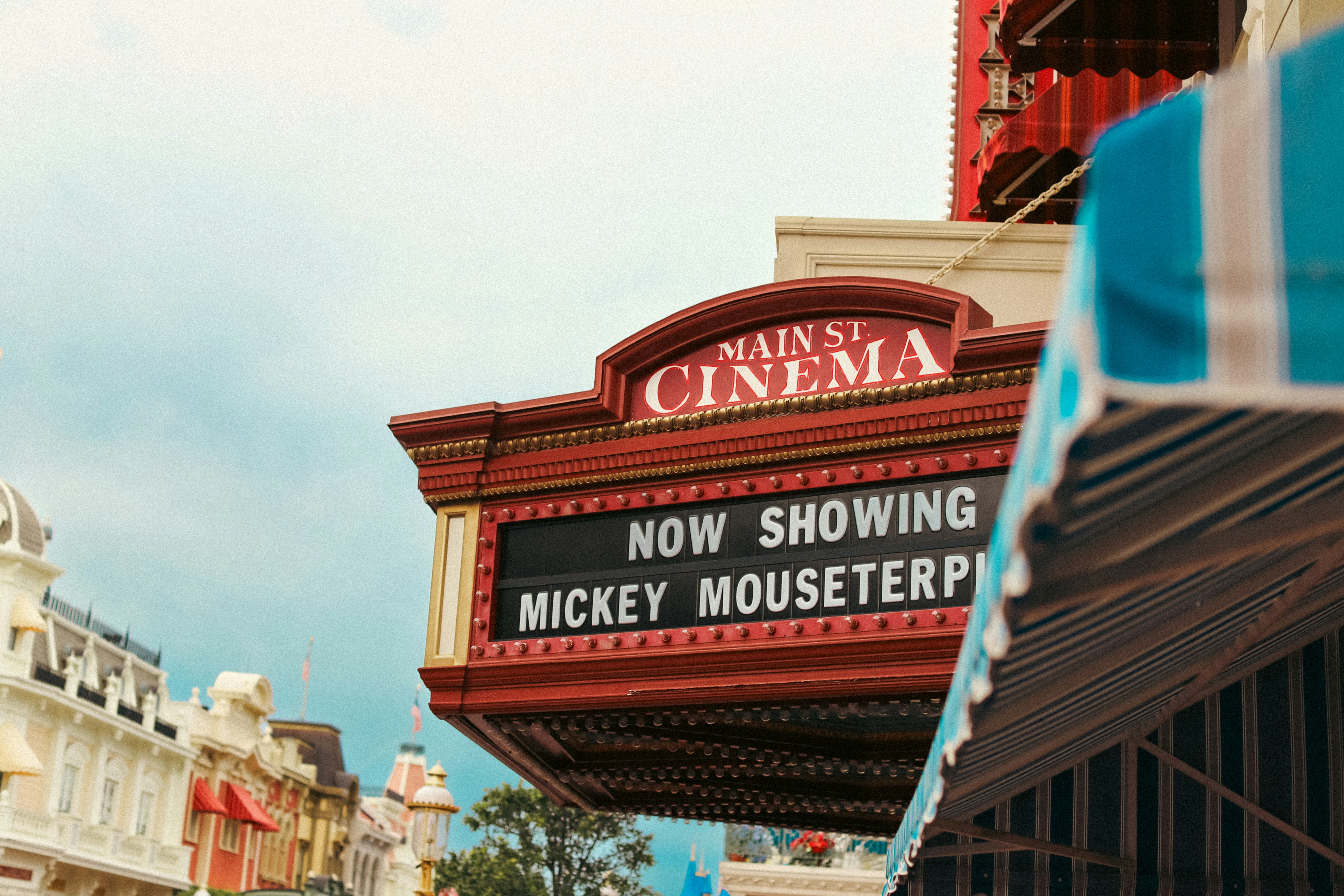 A sign for a movie theater in a city
