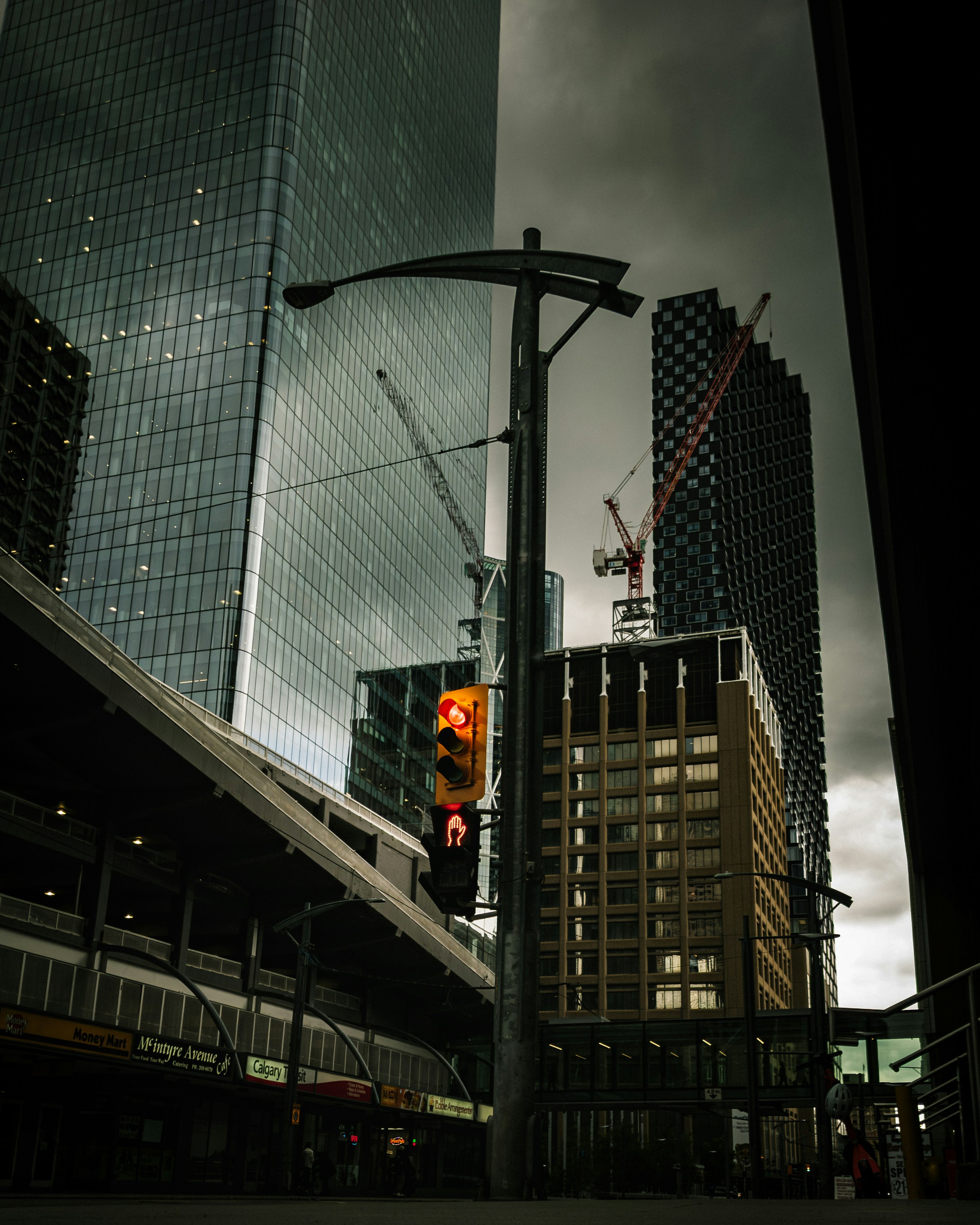 A traffic light on a pole in front of tall buildings photo – Free ...
