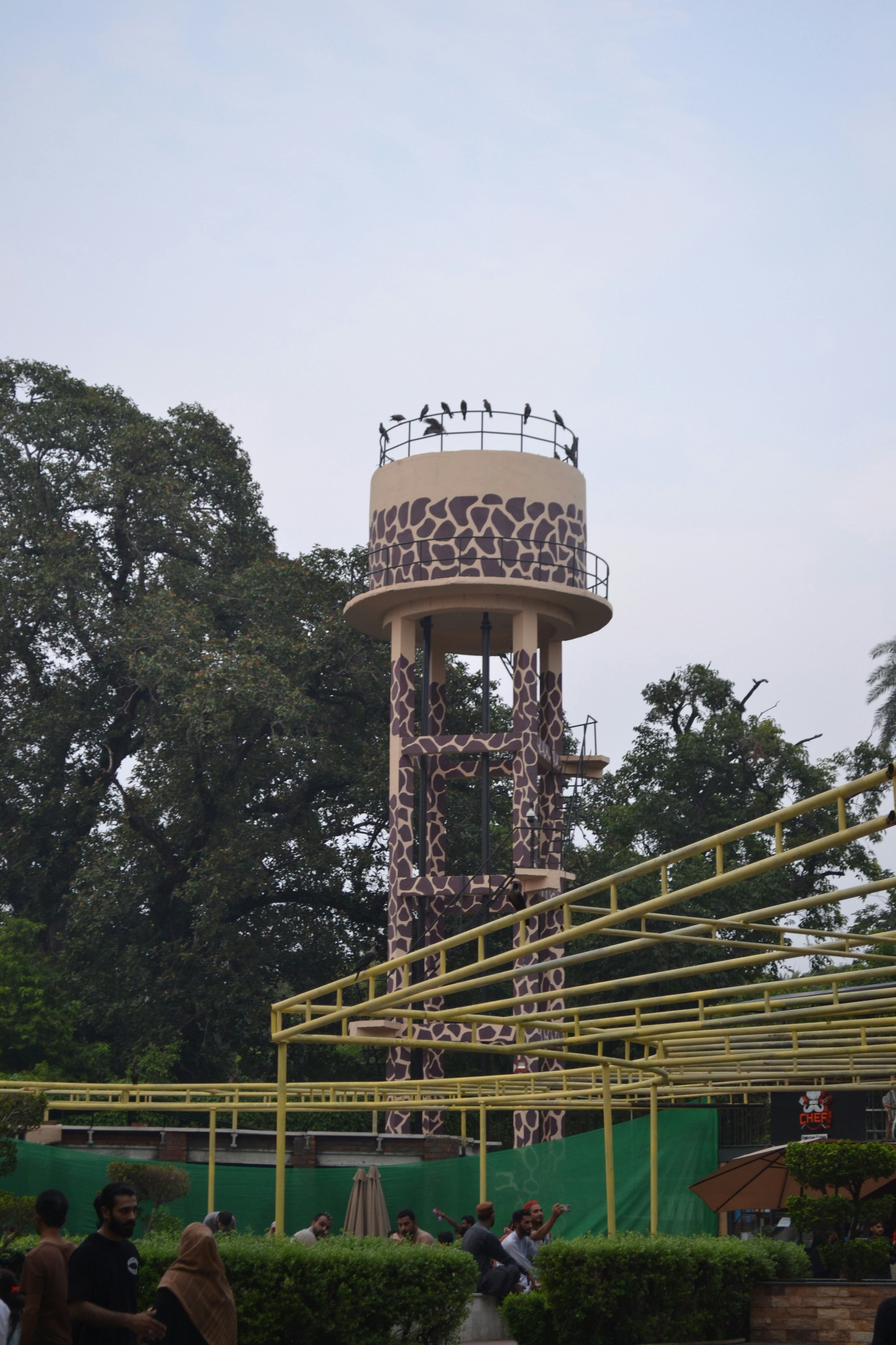Observation Tower with giraffe-patterned columns under a pale sky