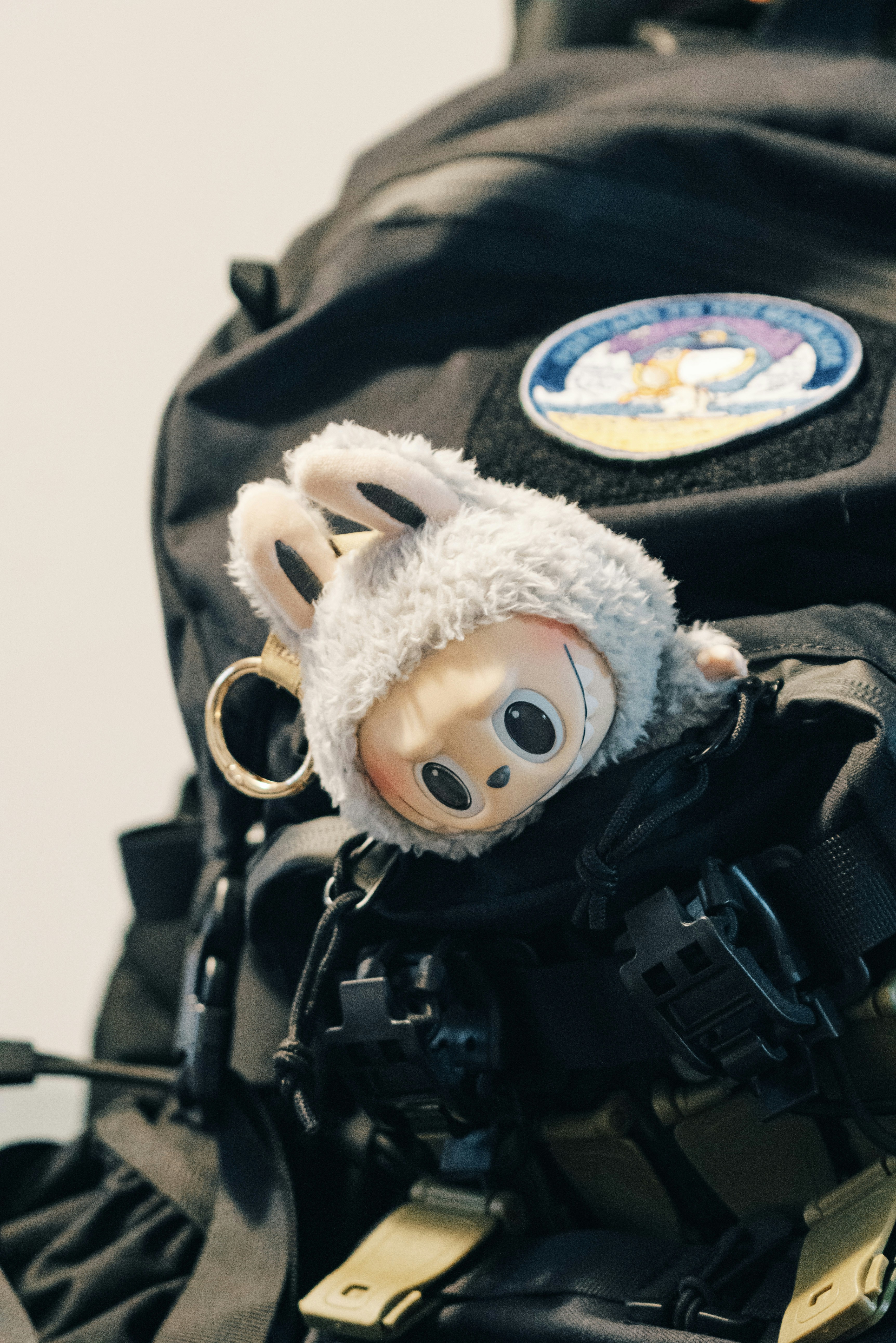 Cozy Bunny Scout: Plush Keychain Adorns a Gear-Ready Backpack