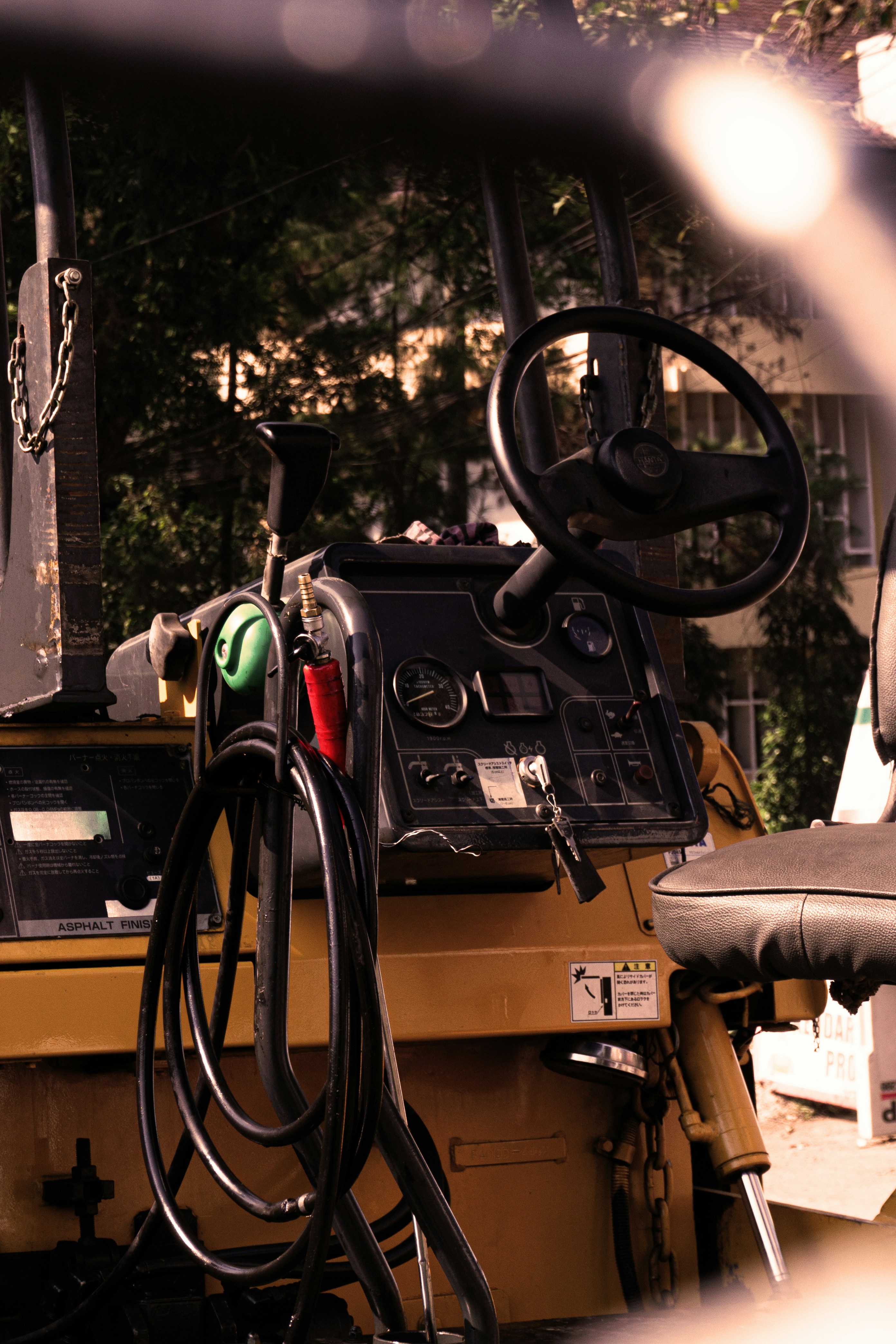 Steering Through Time: The Weathered Control Console of a Yellow Work Vehicle