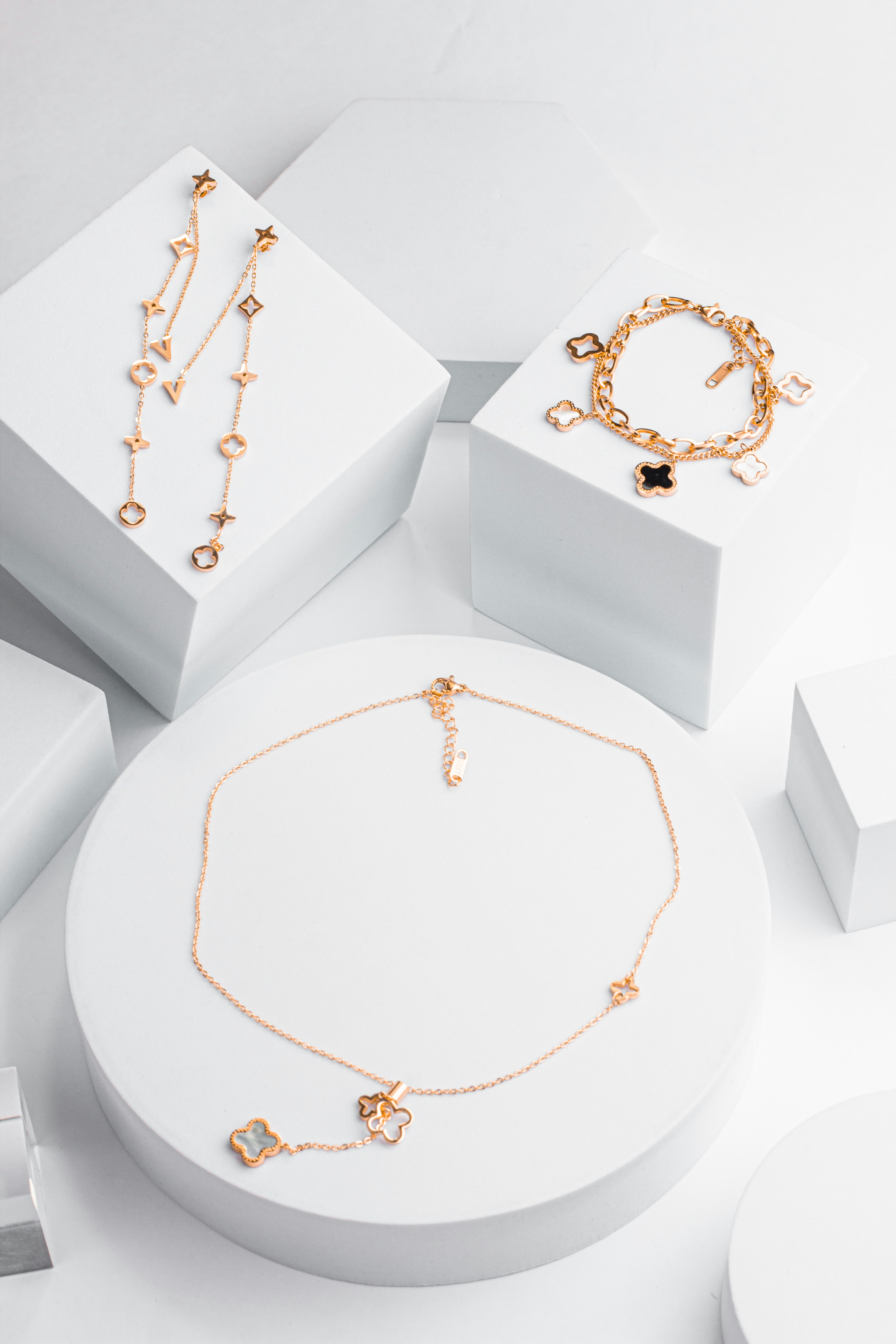 A collection of jewelry on a white surface photo – Free Jewelry Image ...