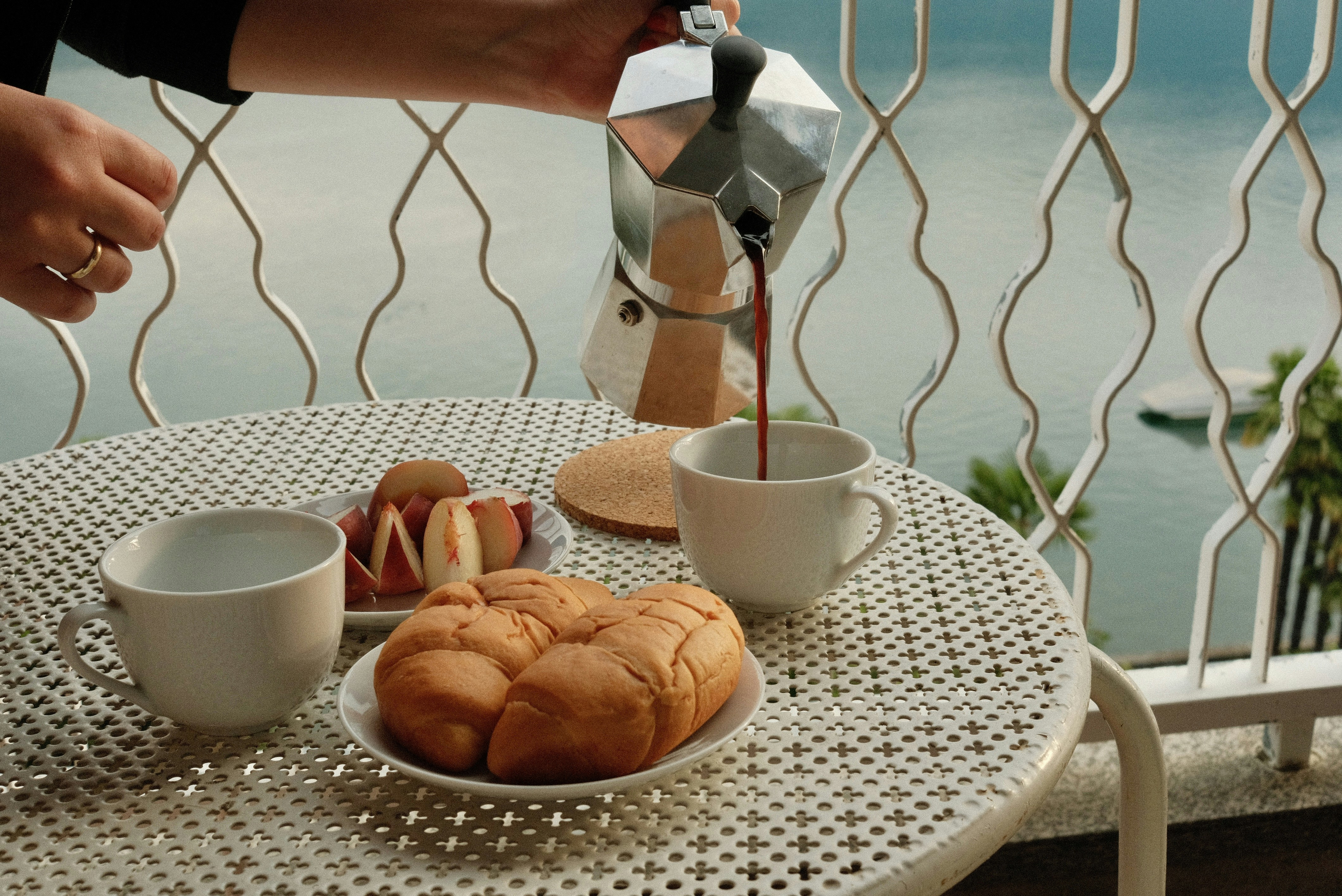 Morning Pour on the Balcony: Croissants, Coffee, and Sea Light