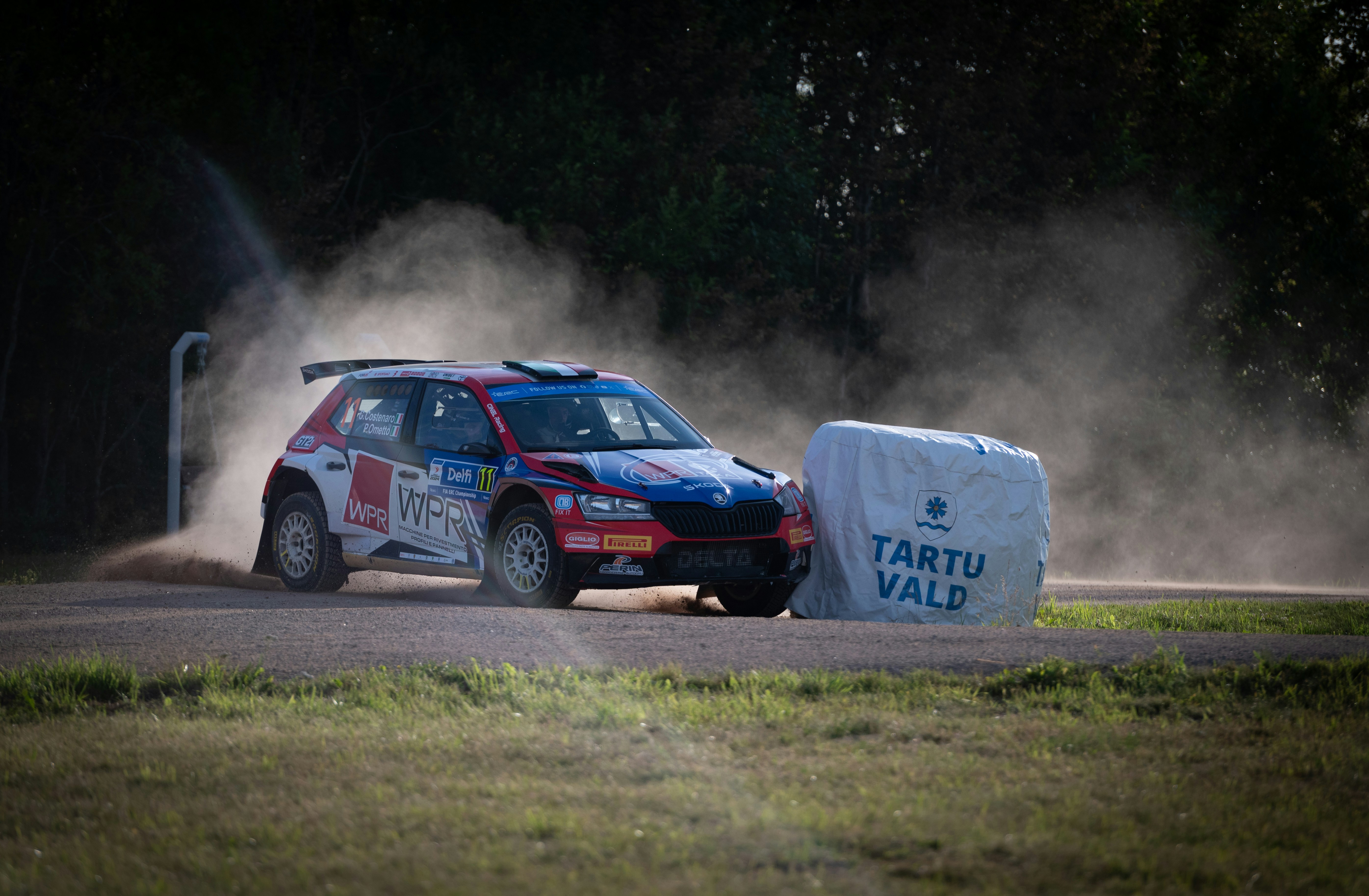 A dirt rally car driving down a dirt road photo – Free Rally Image on ...