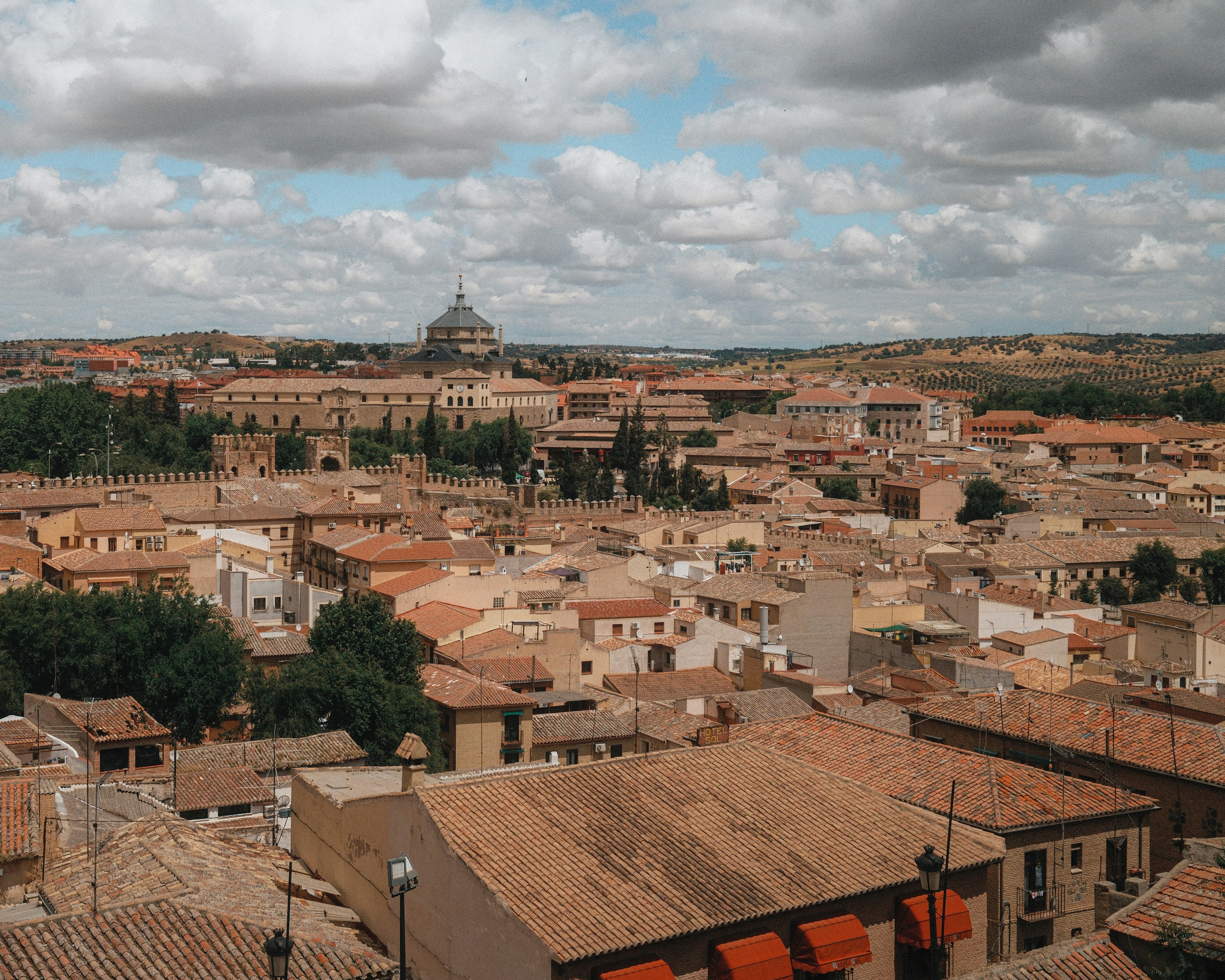 Terracotta Tapestry: A Sunlit Spanish Hilltop Among Red-Tiled Roofs