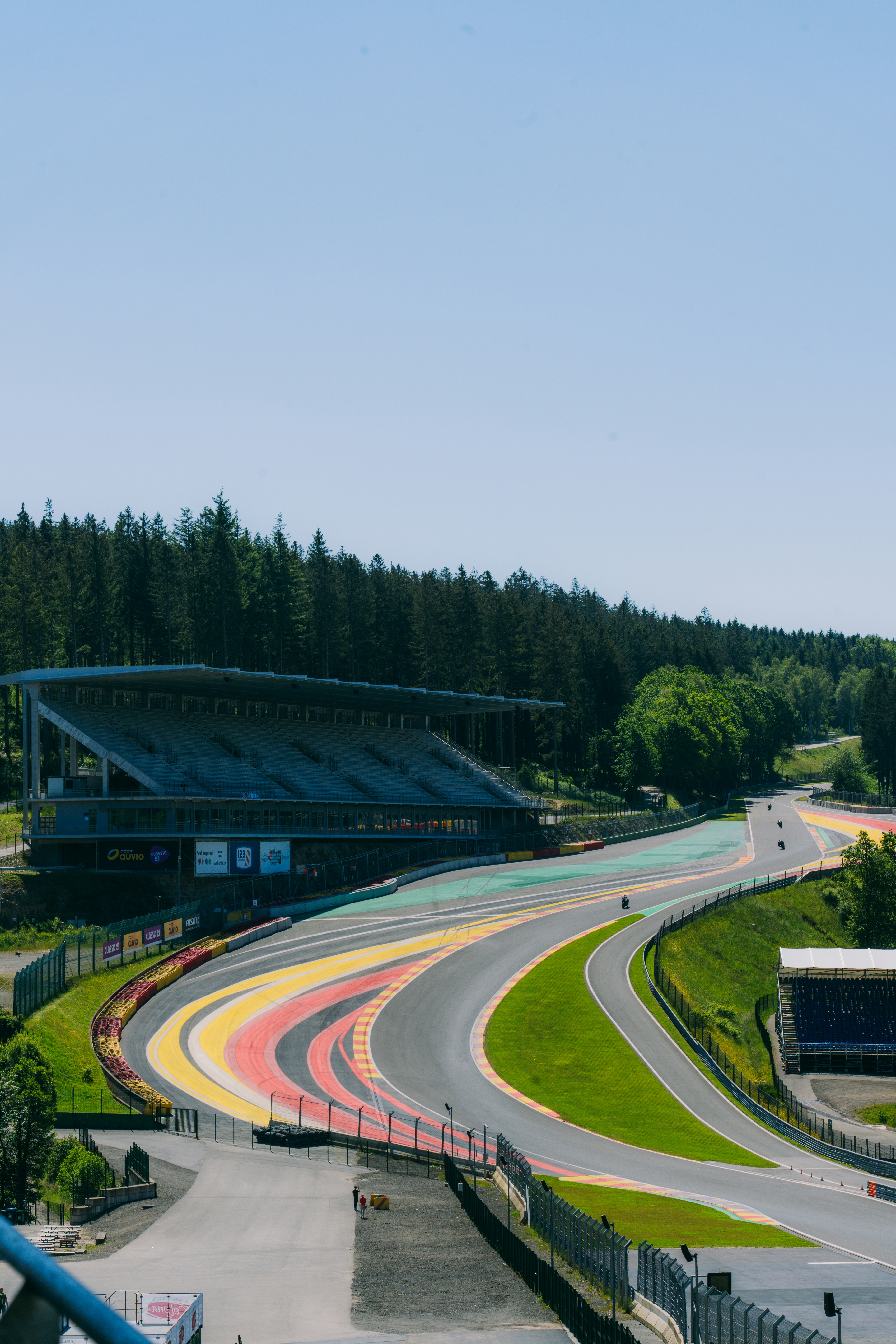 Racing Circuit Aerial: Sunlit Curves and Grandstand Edges