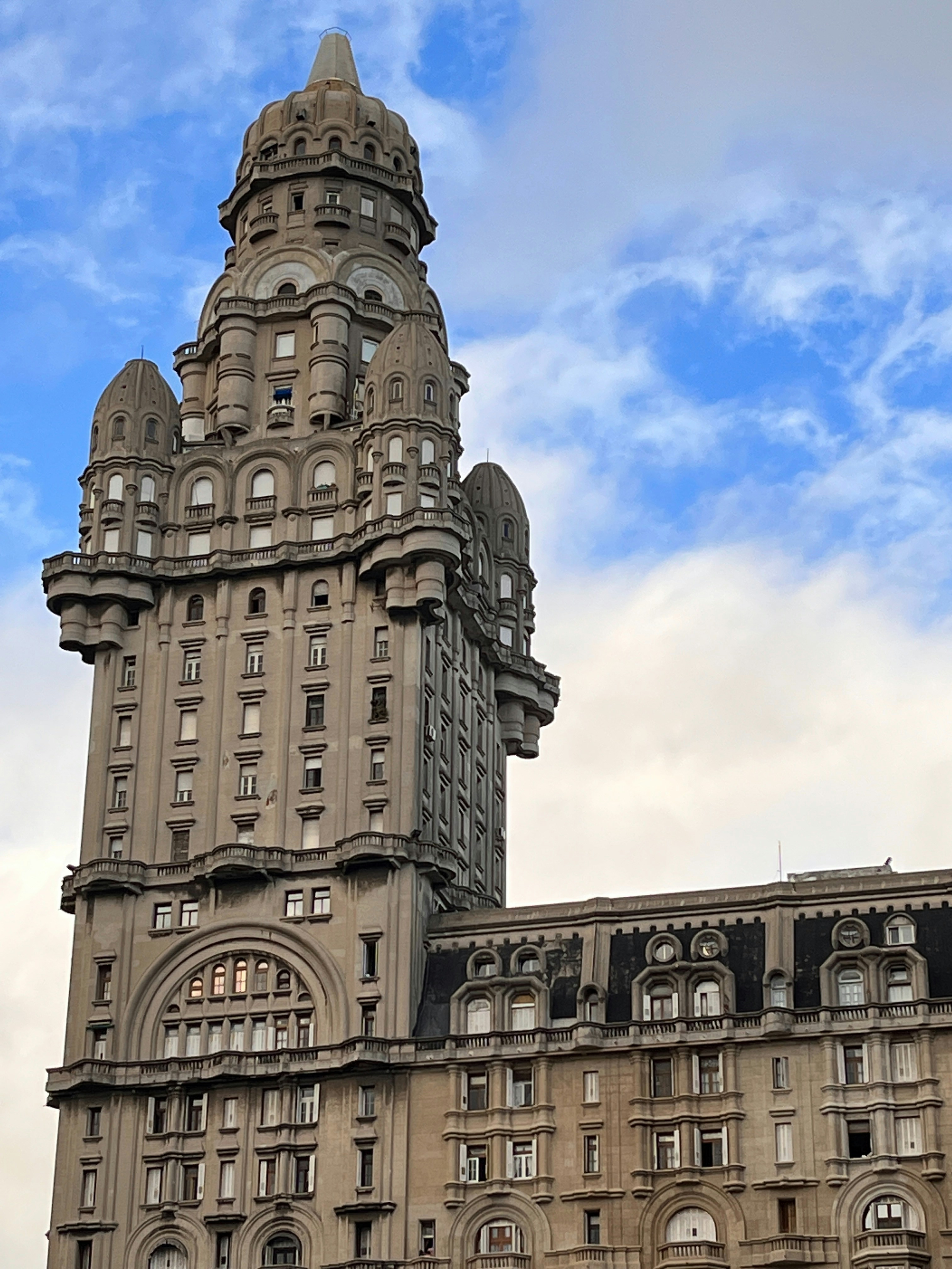 Historic building with intricate architectural details and a striking tower against a blue sky.