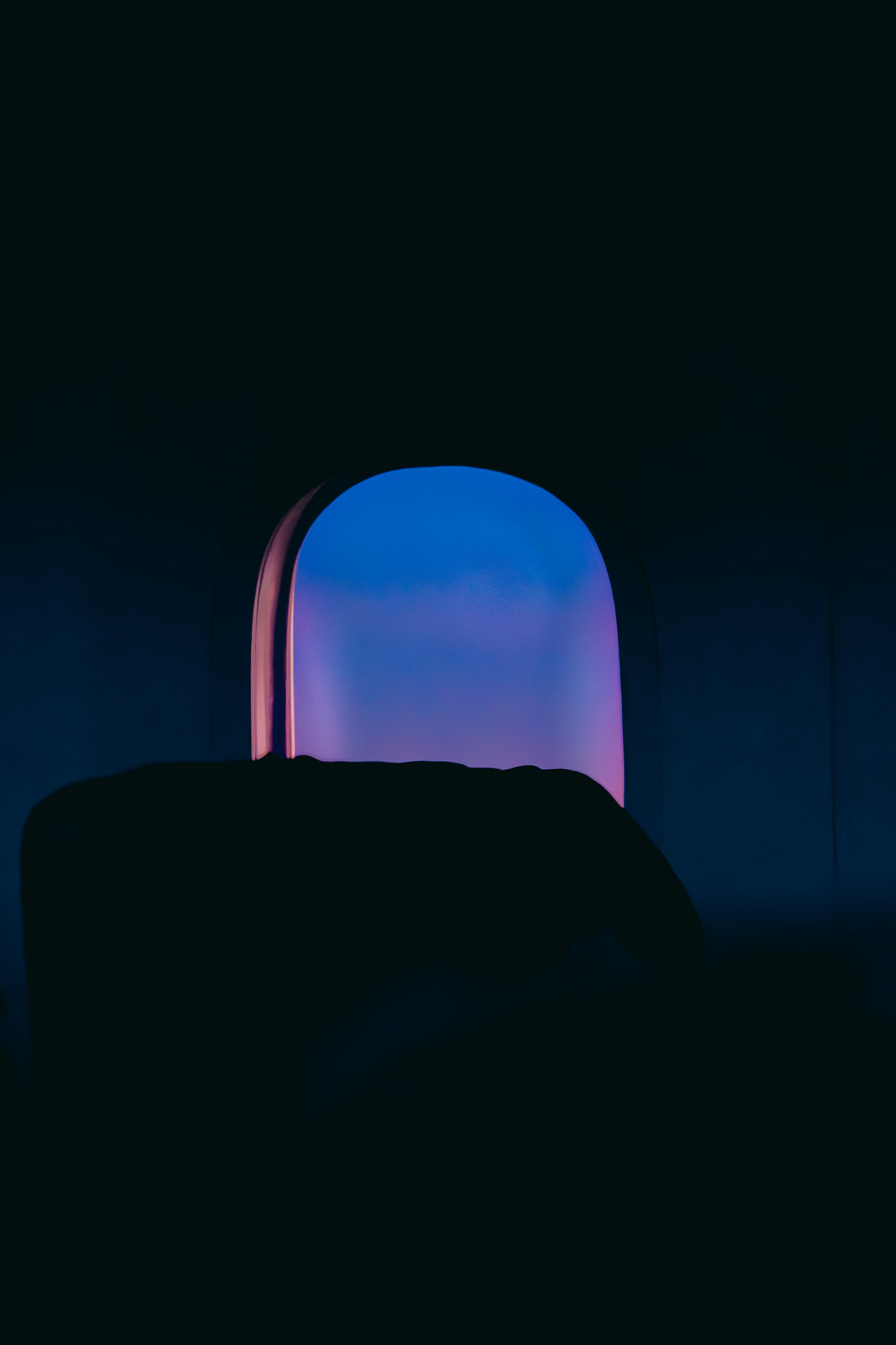 Arched Neon Window in a Dark Cabin