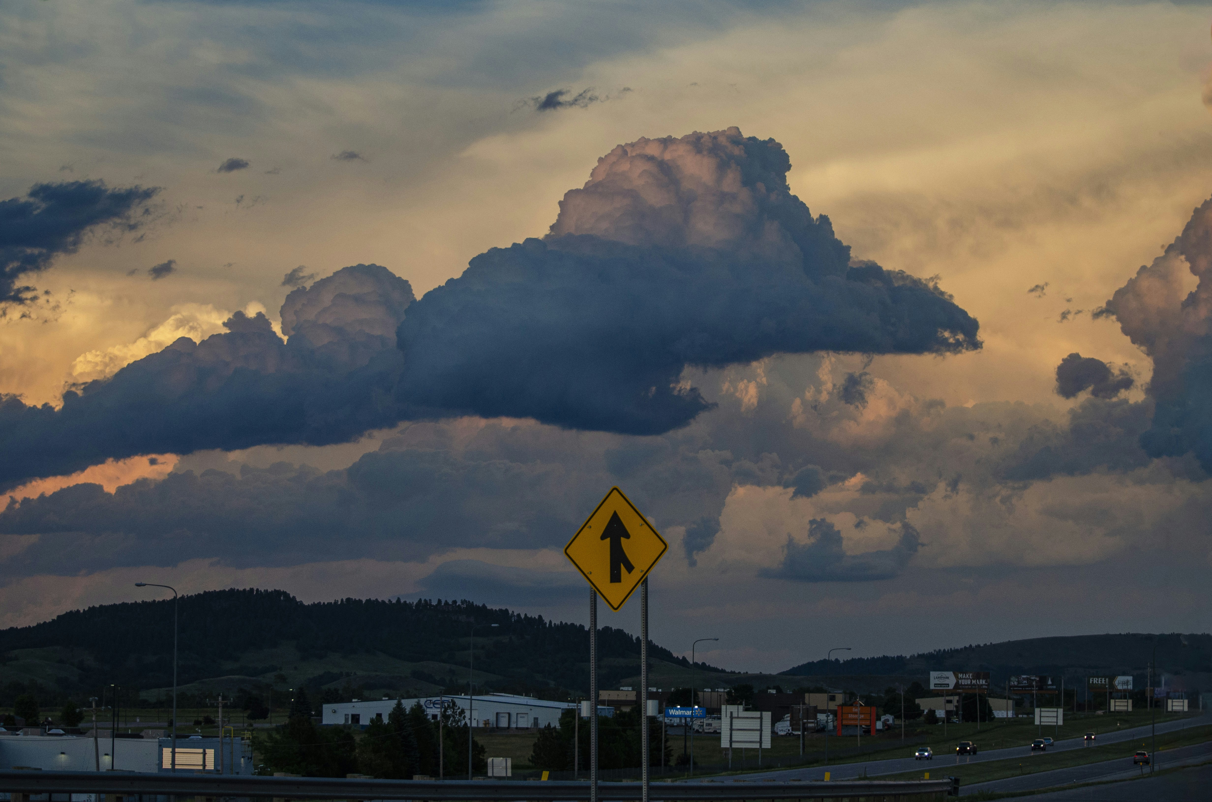 Road Sign Silhouette Beneath a Sky of Roving Clouds