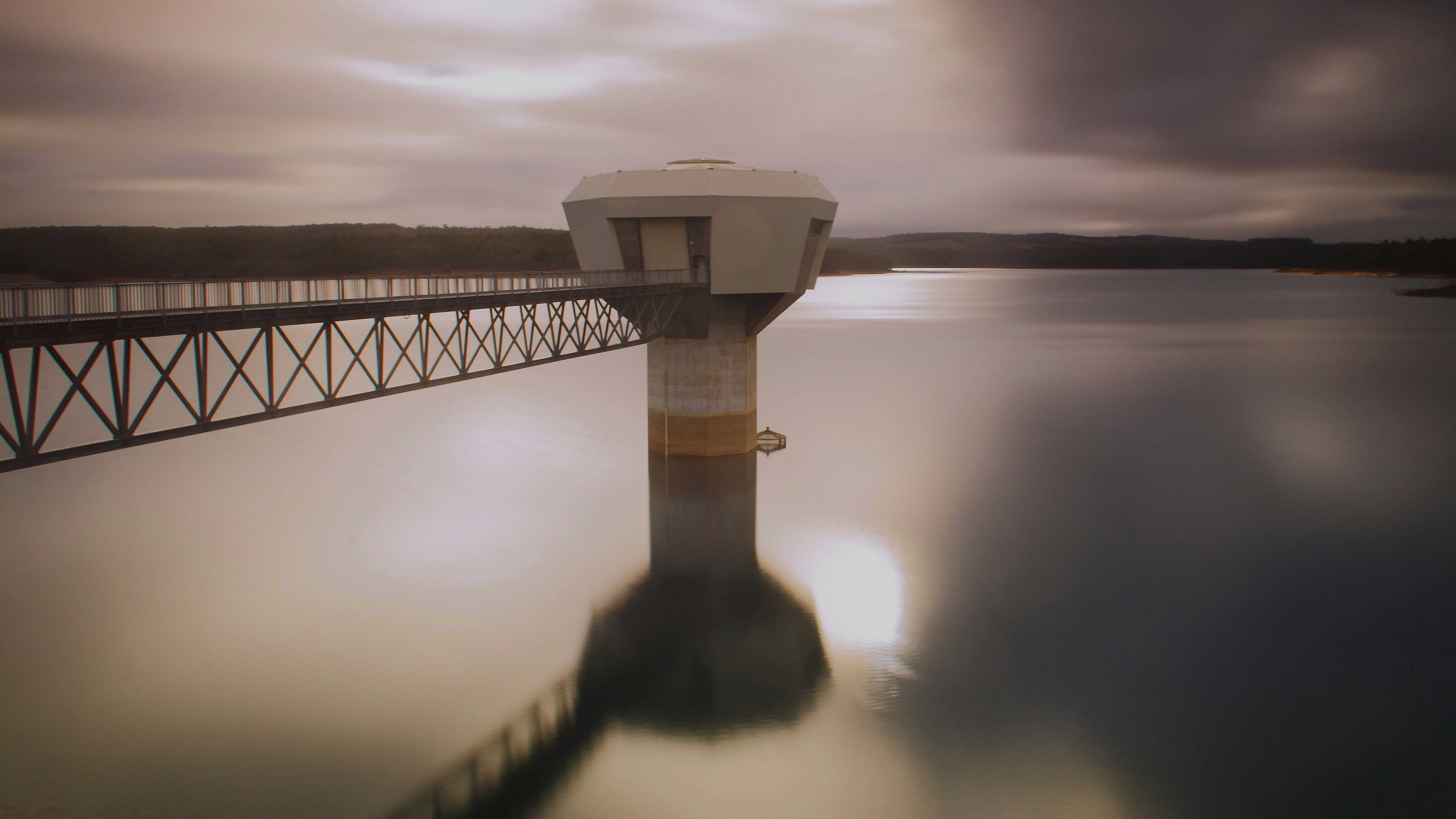 Beacon at the Quiet Reach: A Concrete Pier End Over Calm Water