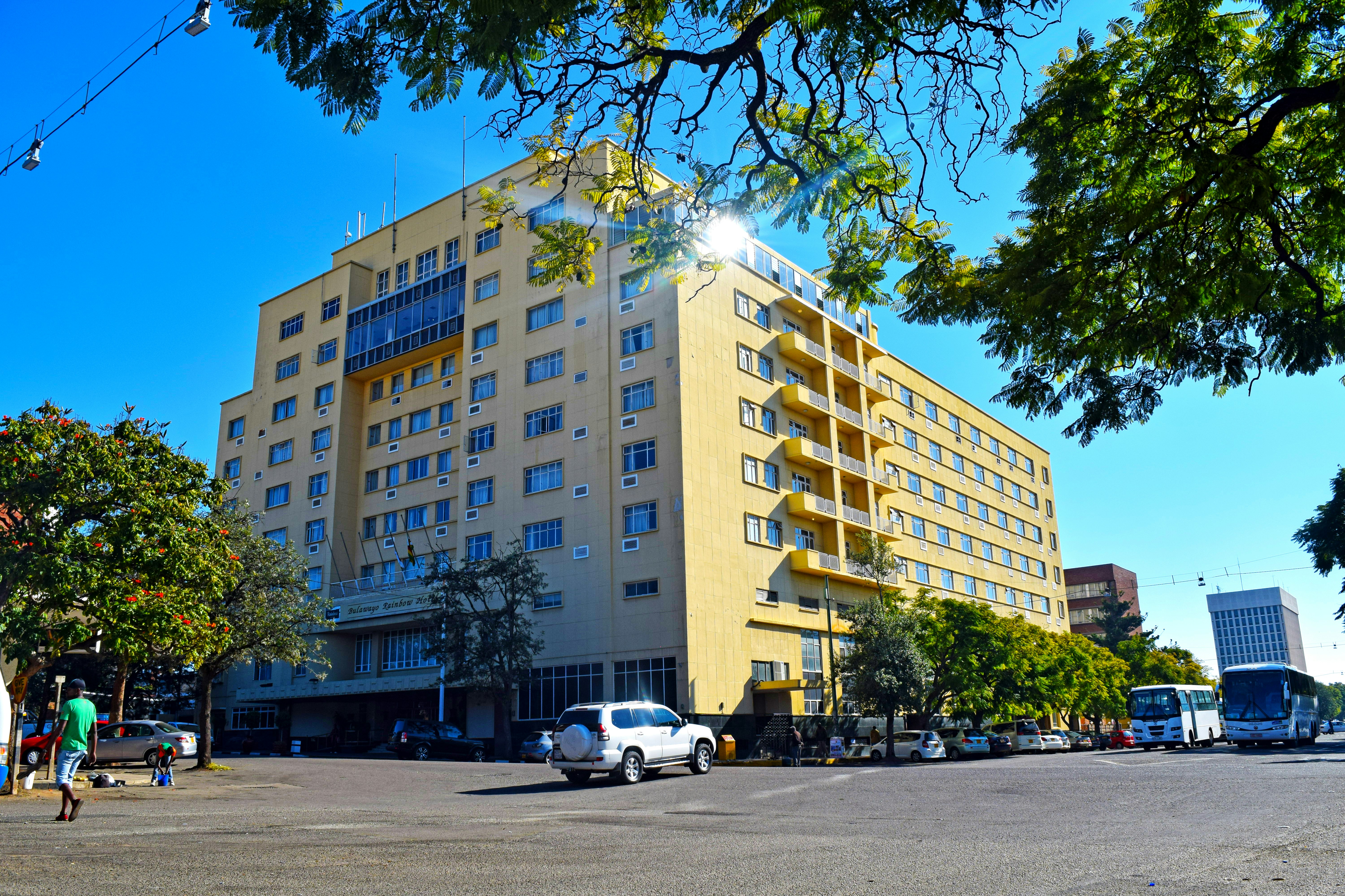 A large yellow building sitting on the side of a road photo – Free ...