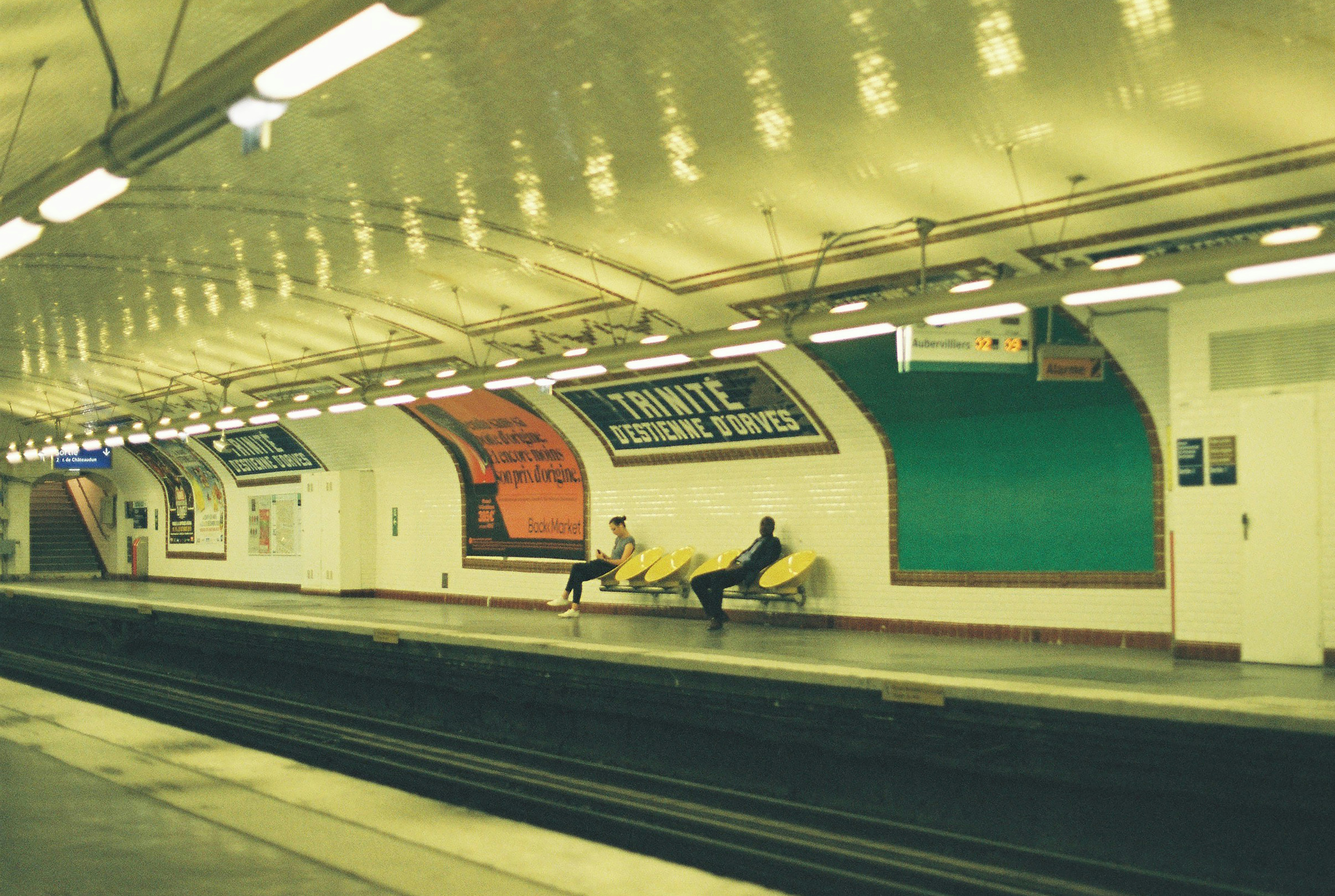 Quiet Interlude on a Green-Tiled Underground Platform