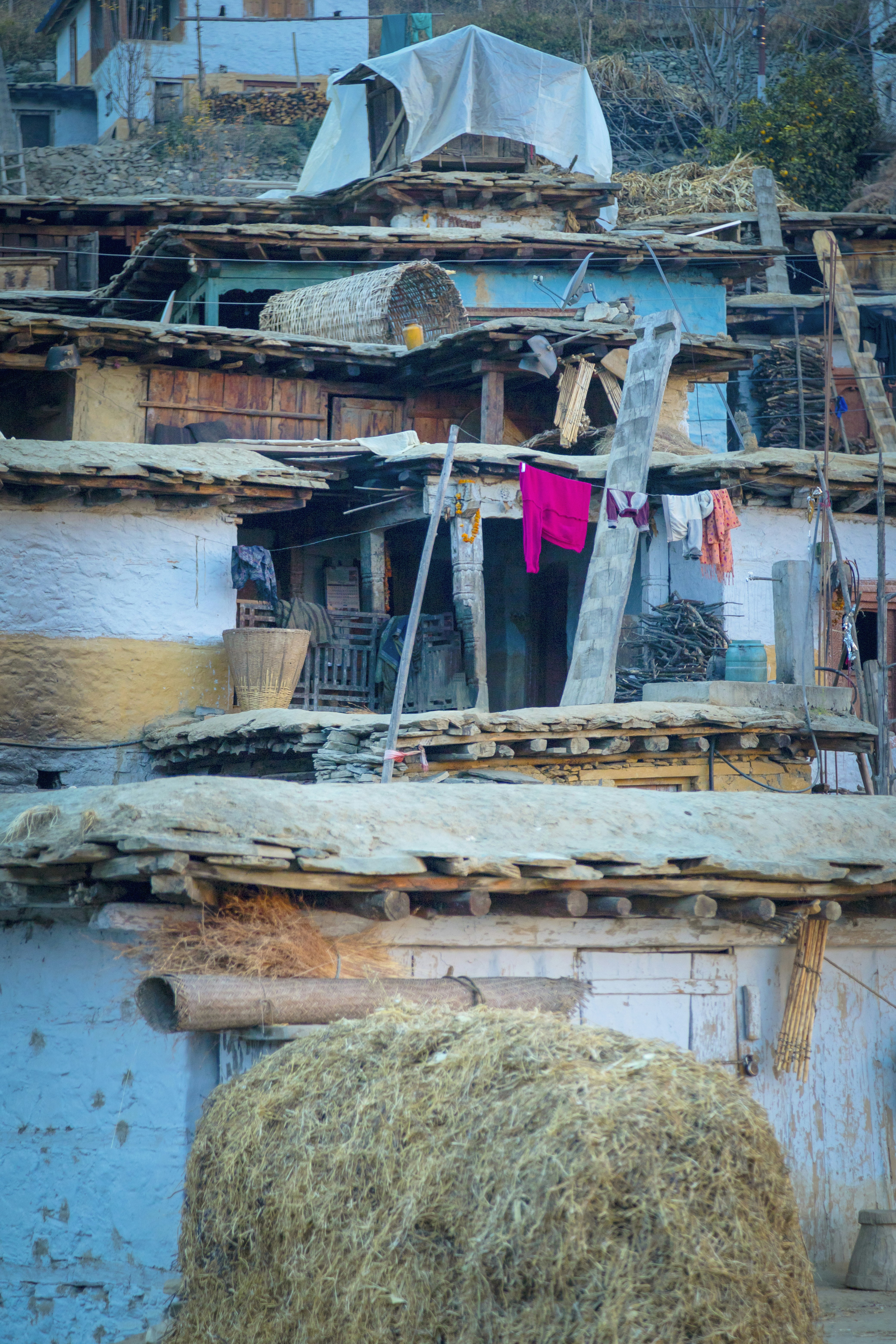 A building with a bunch of bales of hay in front of it photo – Free ...