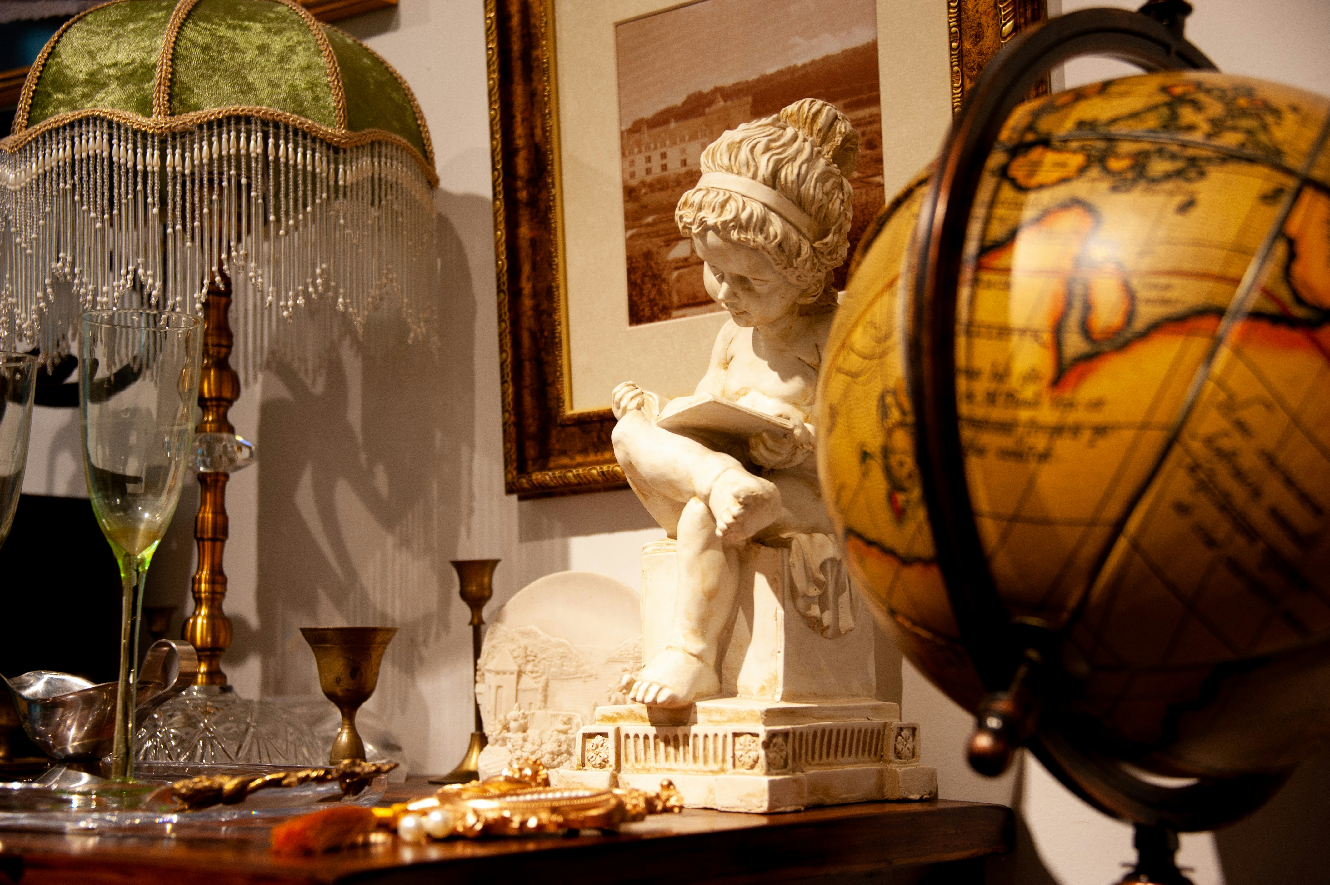 Cherubic Scholar Beside a Globe: A Quiet Still-Life of Timeworn Treasures