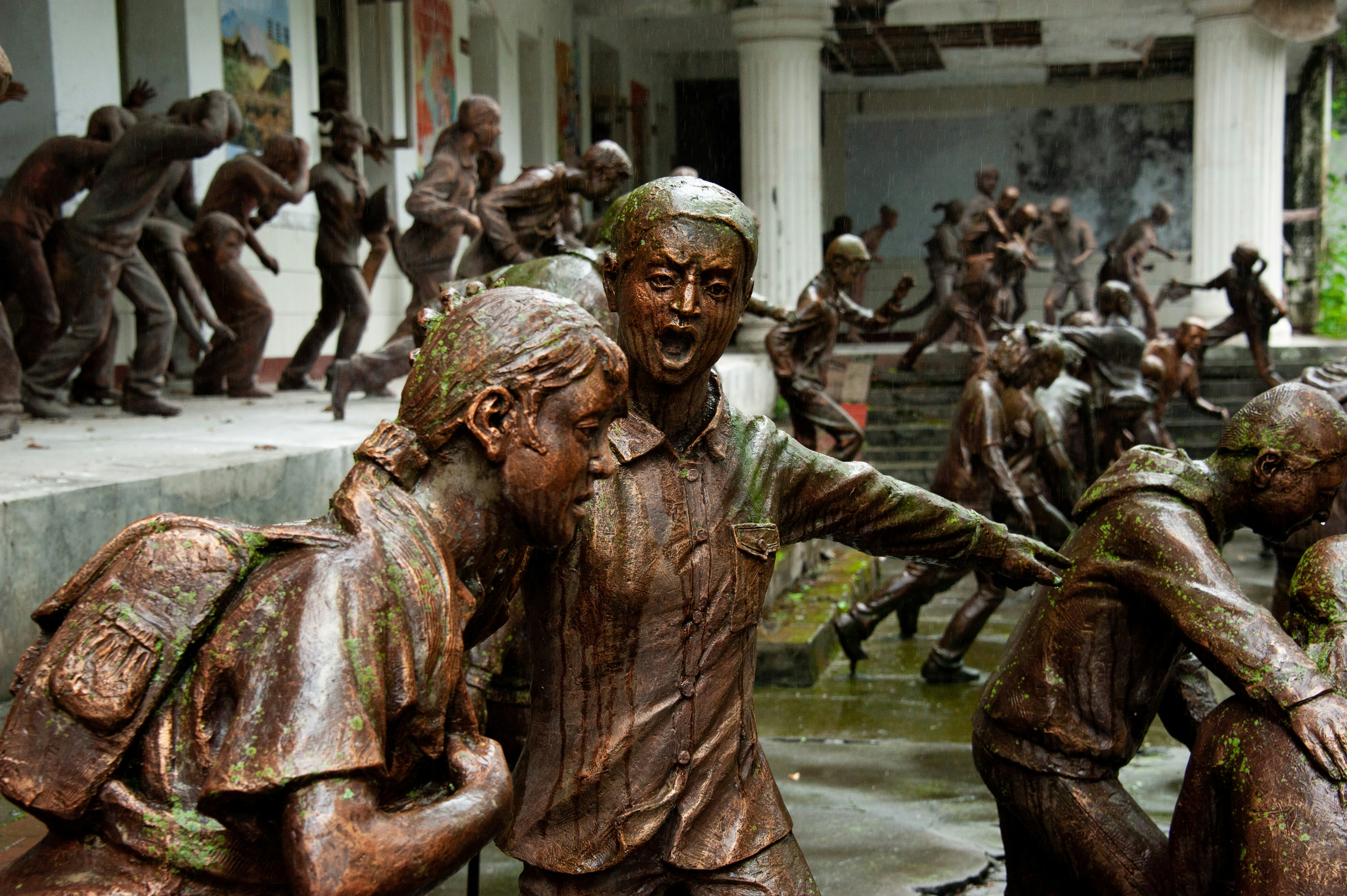 A group of bronze statues of people in a courtyard photo – Free Adult ...